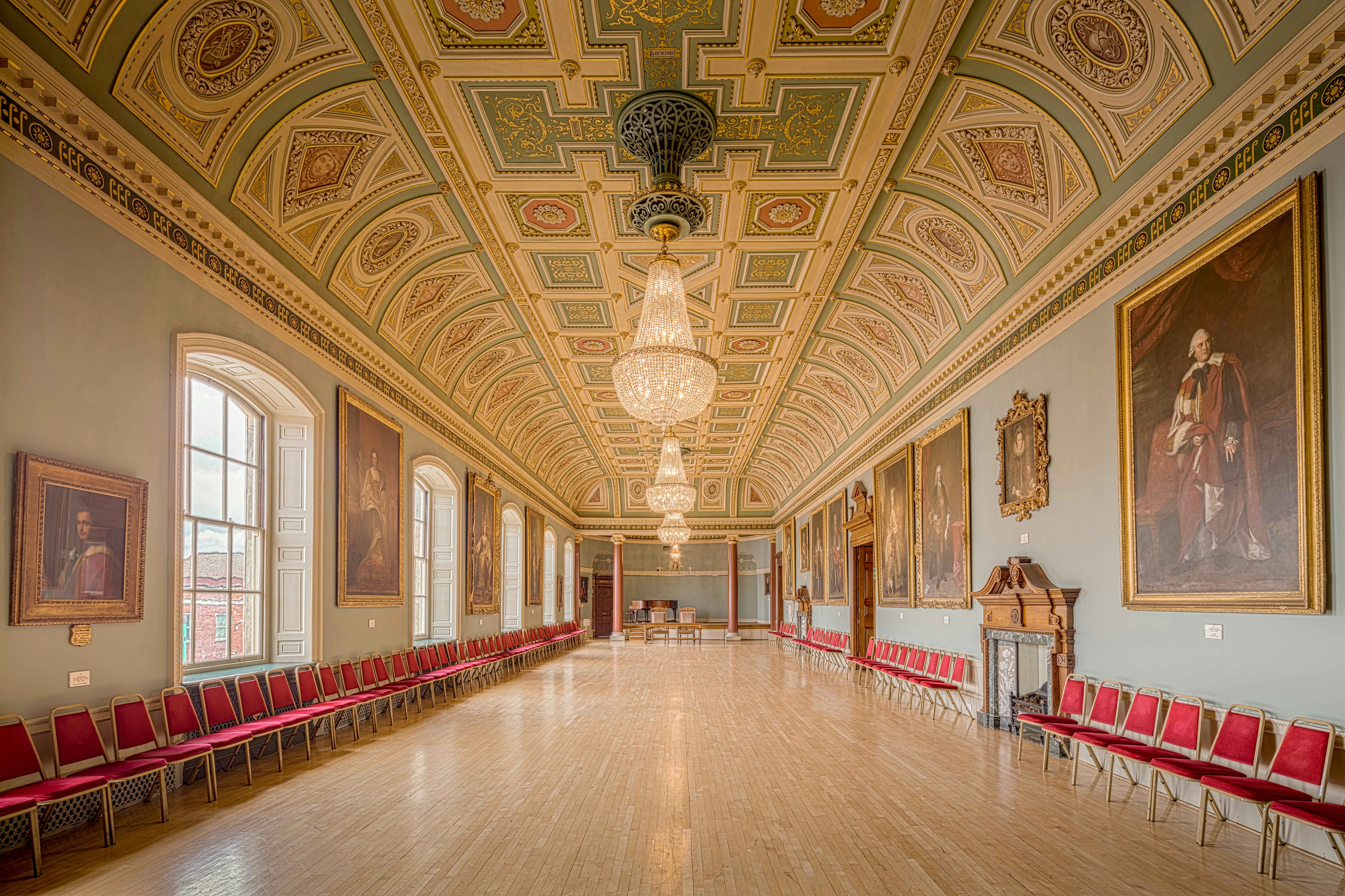 Opulent Hallway of Portraits: A Symmetry of Light and Wood