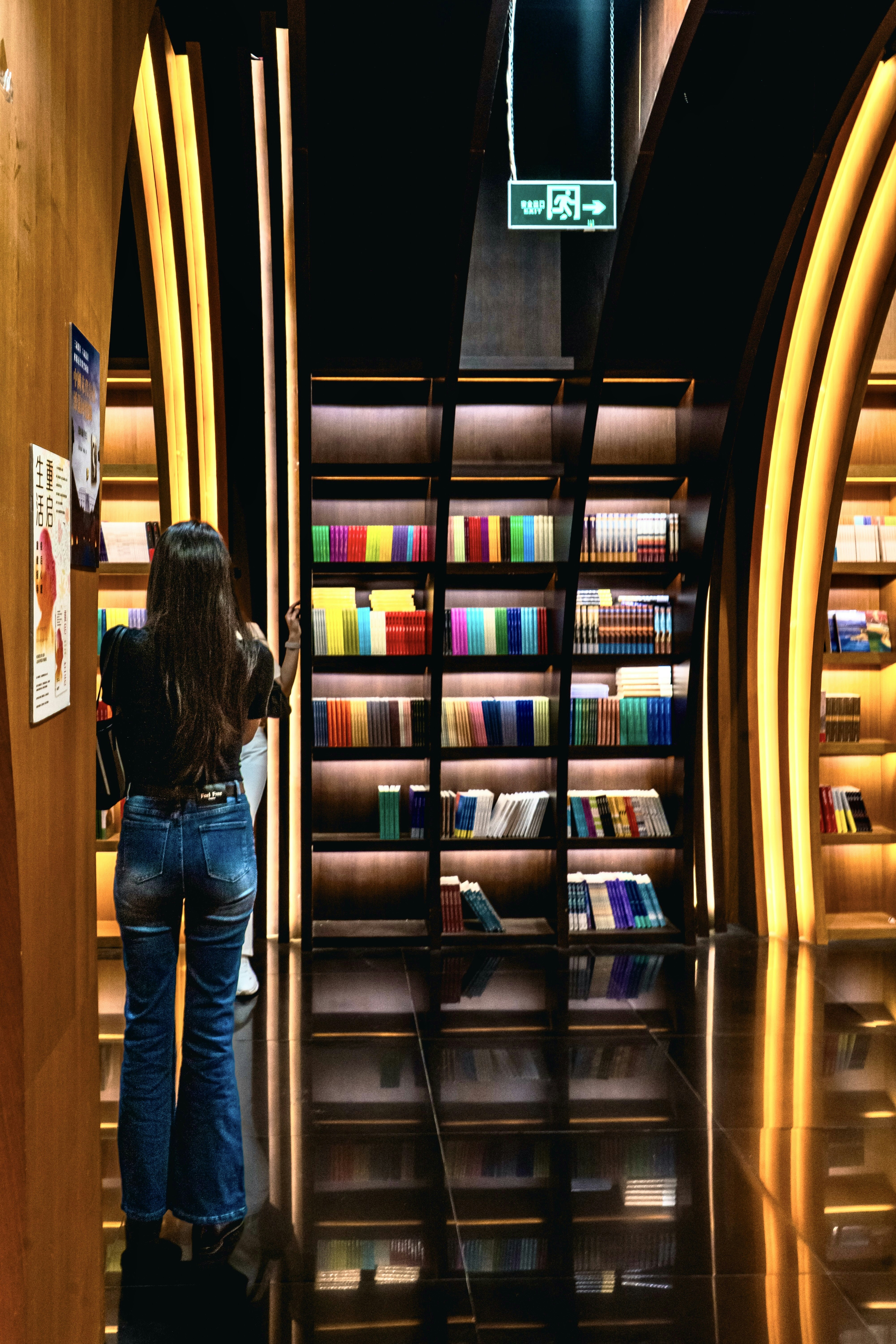 Shelf Symphony: A Woman in a Neon-Glow Library Corridor