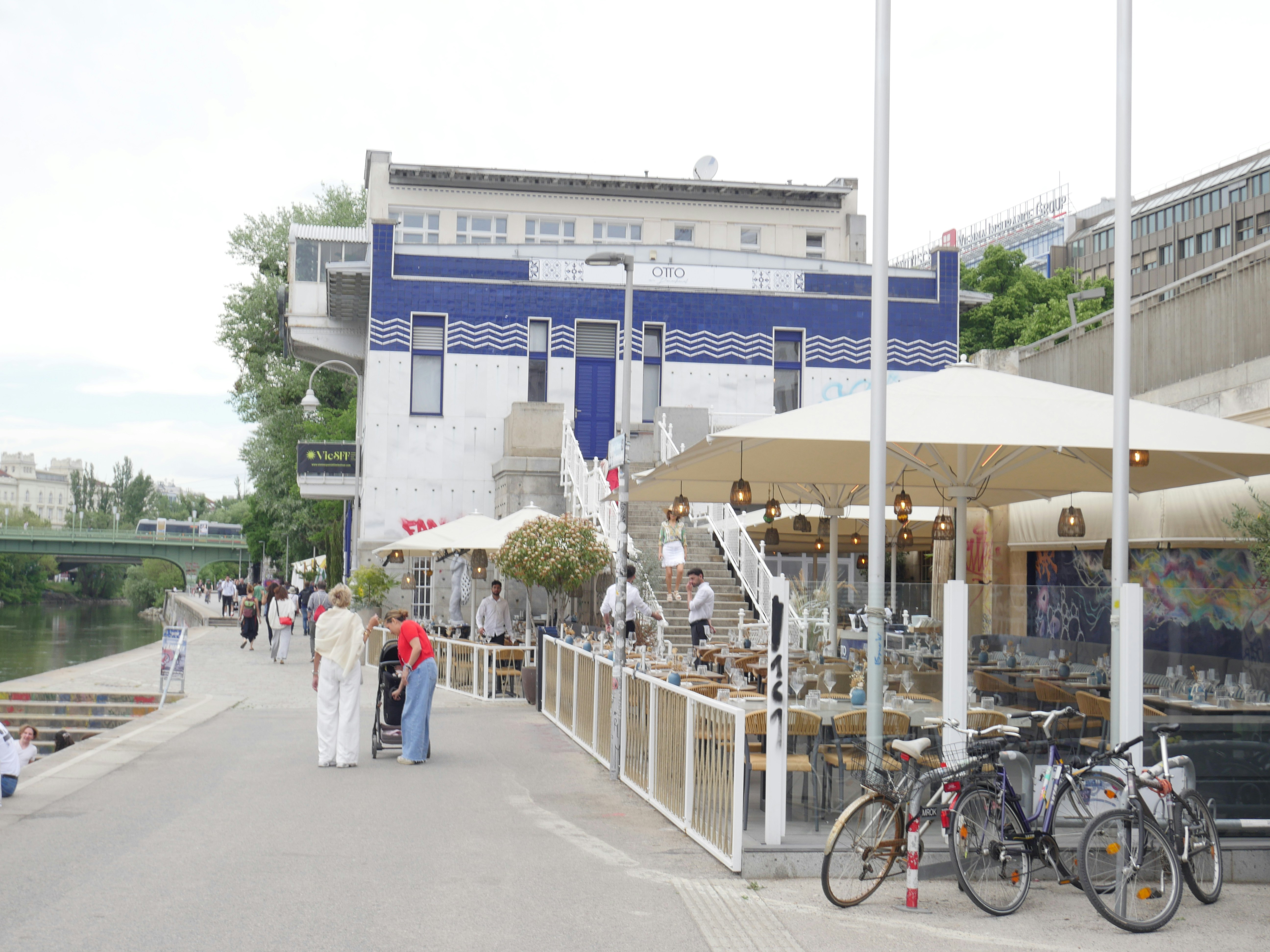Blue-Walled Building by the Riverfront Café