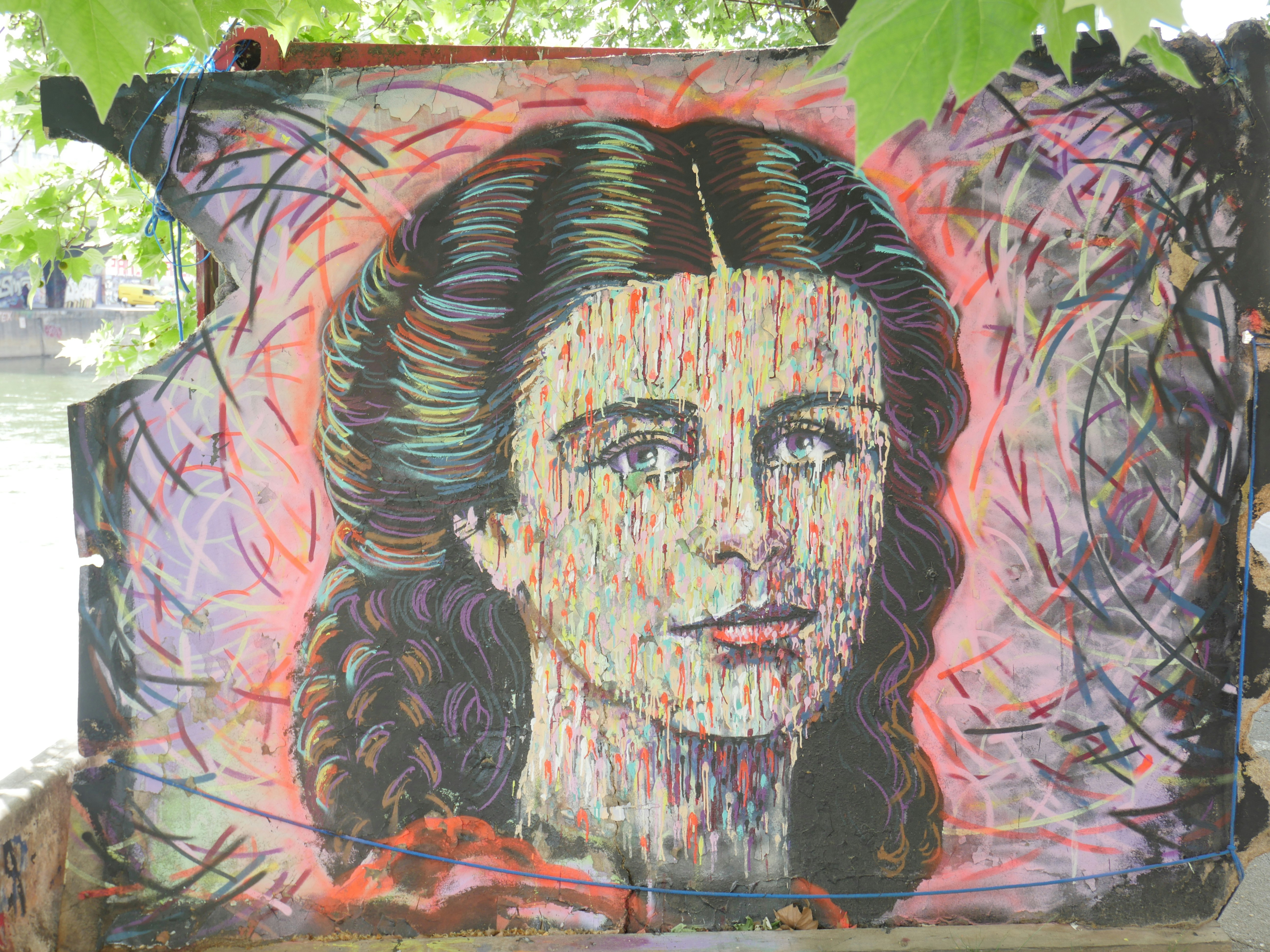 Vivid Portrait on Concrete: A Graffiti Mosaic of a Woman