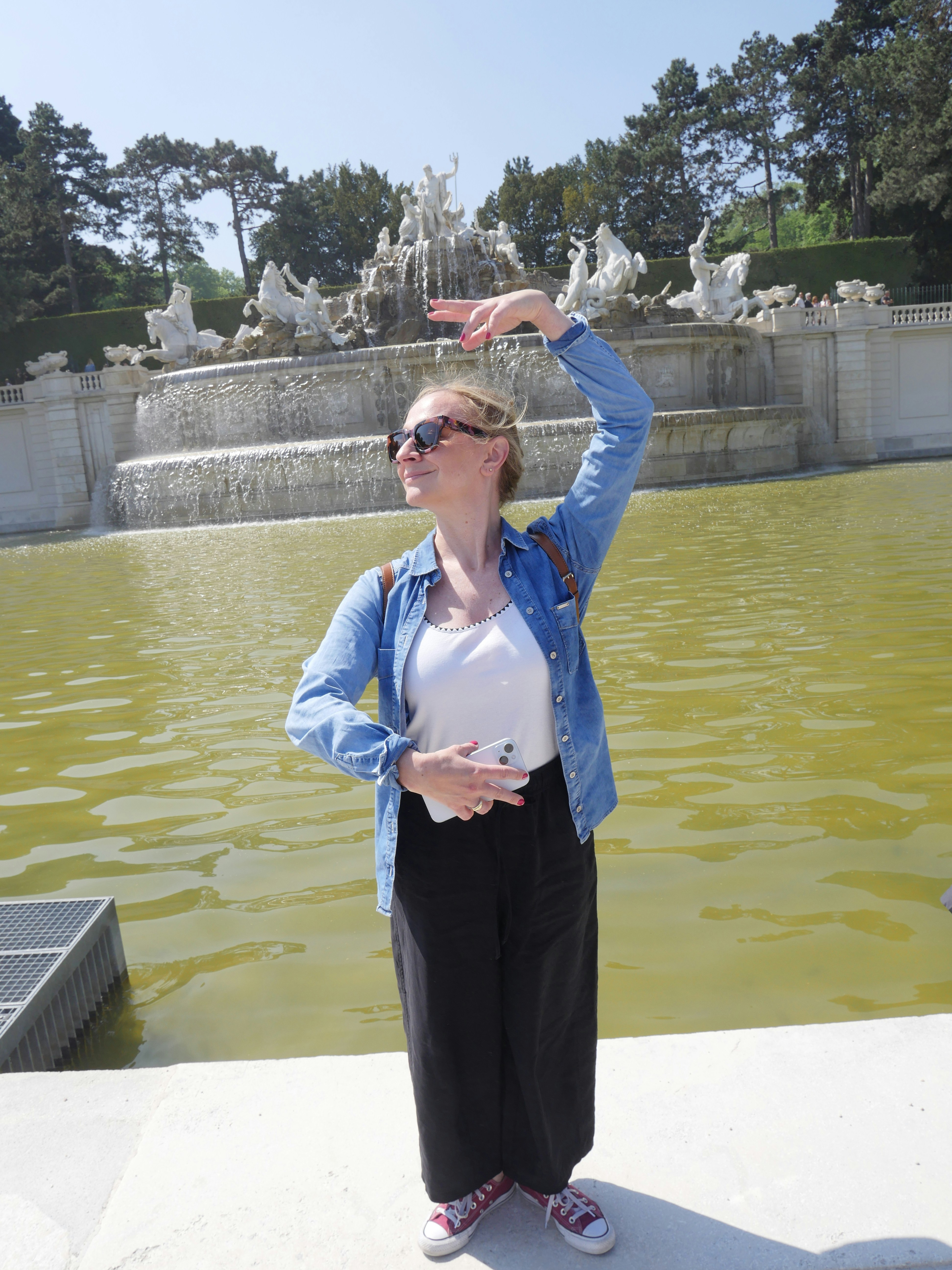 Gesture Under the Fountain: A Woman Aligned with the Sculpted Cascade