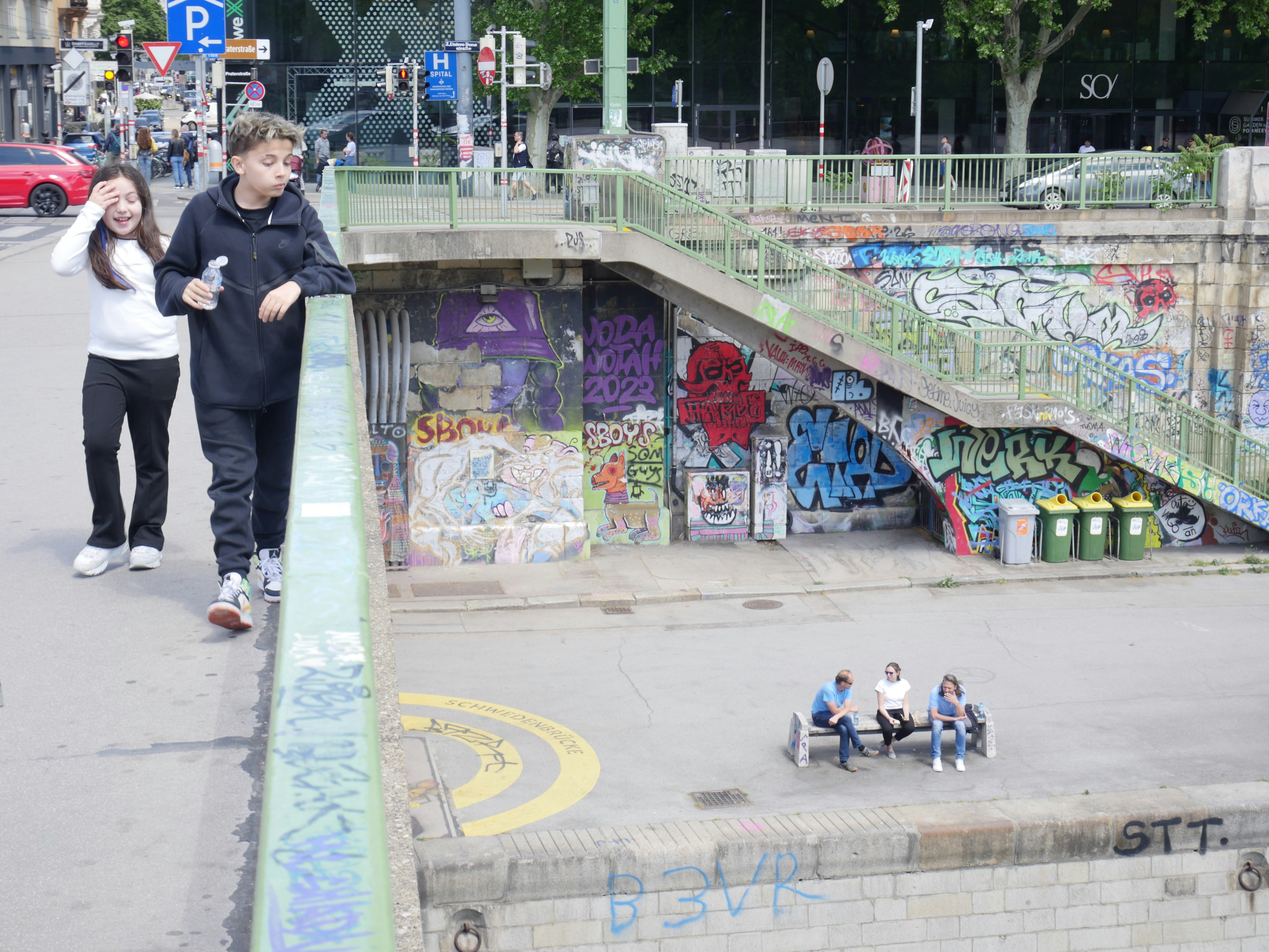 Graffiti Bank: Teenagers on a Bridge Over an Alley of Street Art