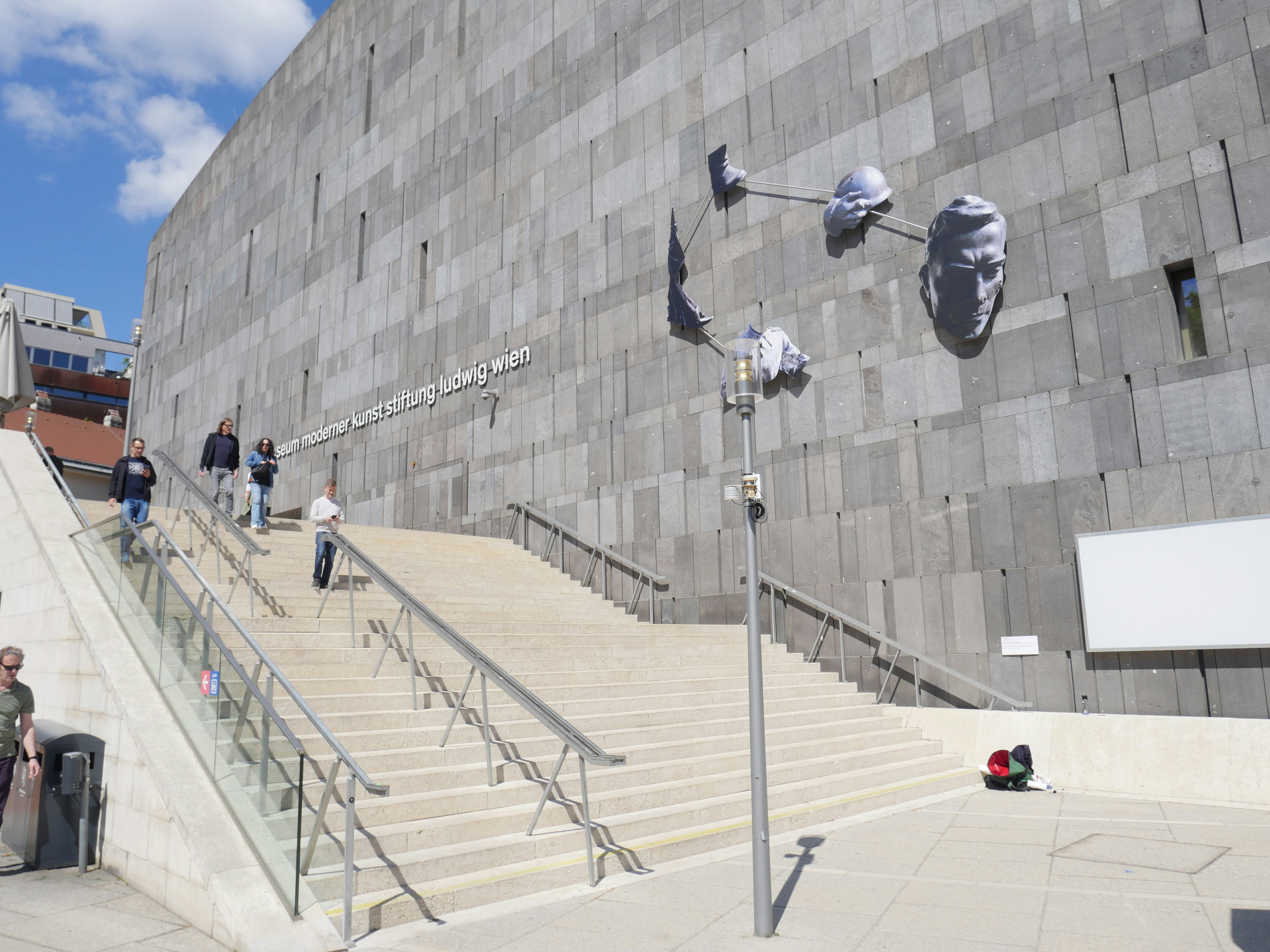 Staircase to Culture: A Modern Facade with Floating Portraits
