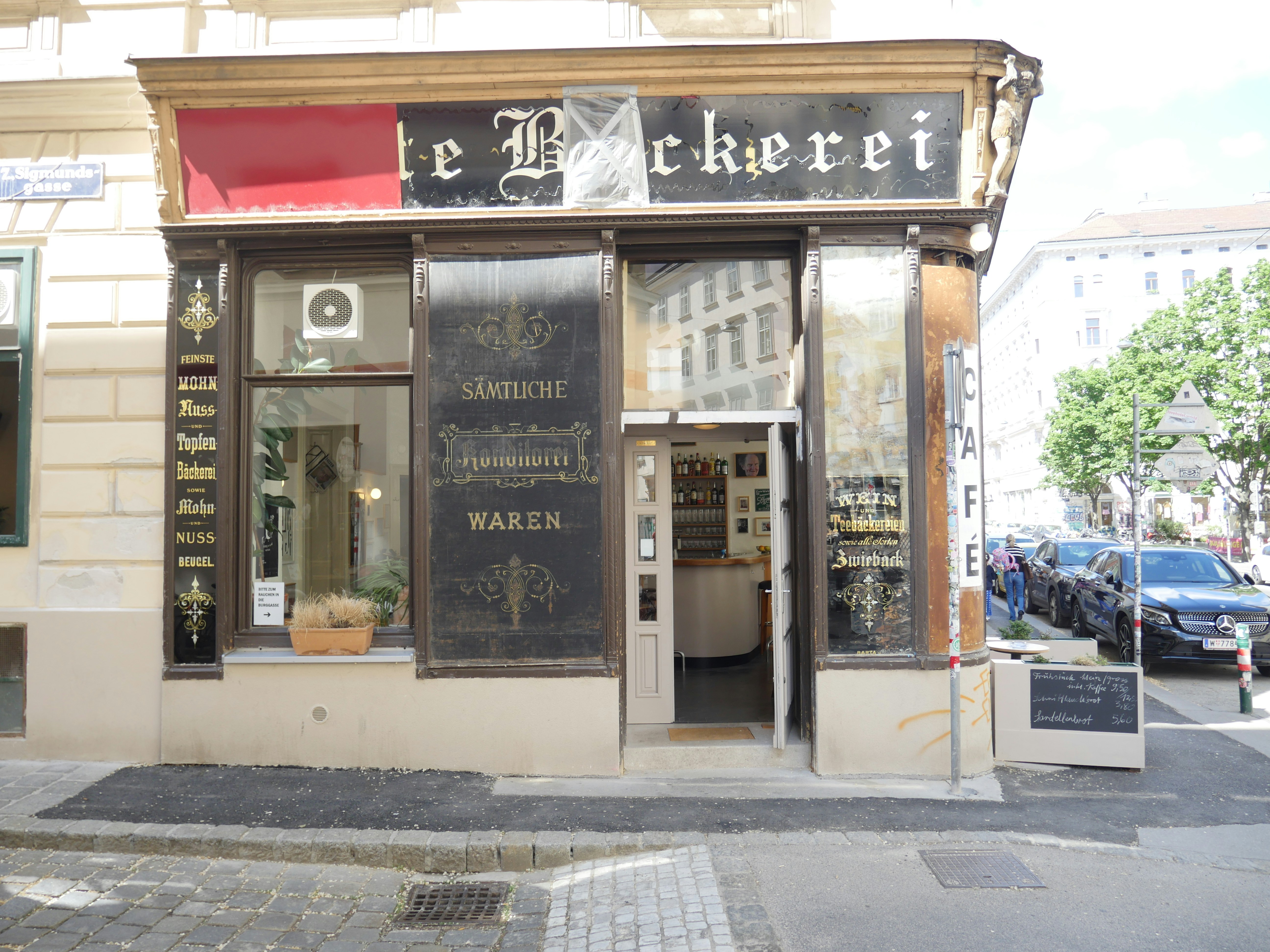 Old-fashioned bakery shop with gold lettering on a city street.