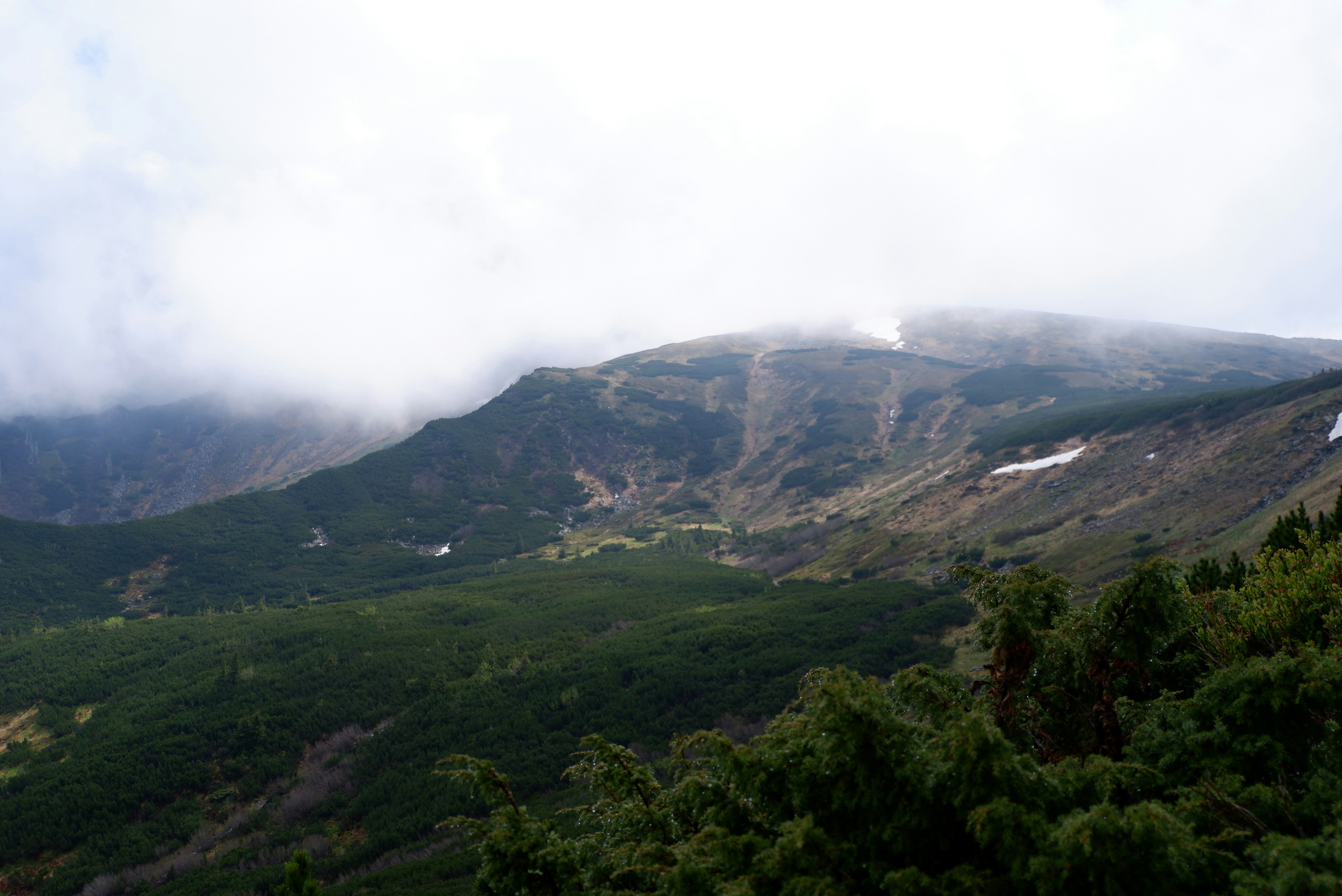 Clouds Weave Over a Quiet Mountain Rim