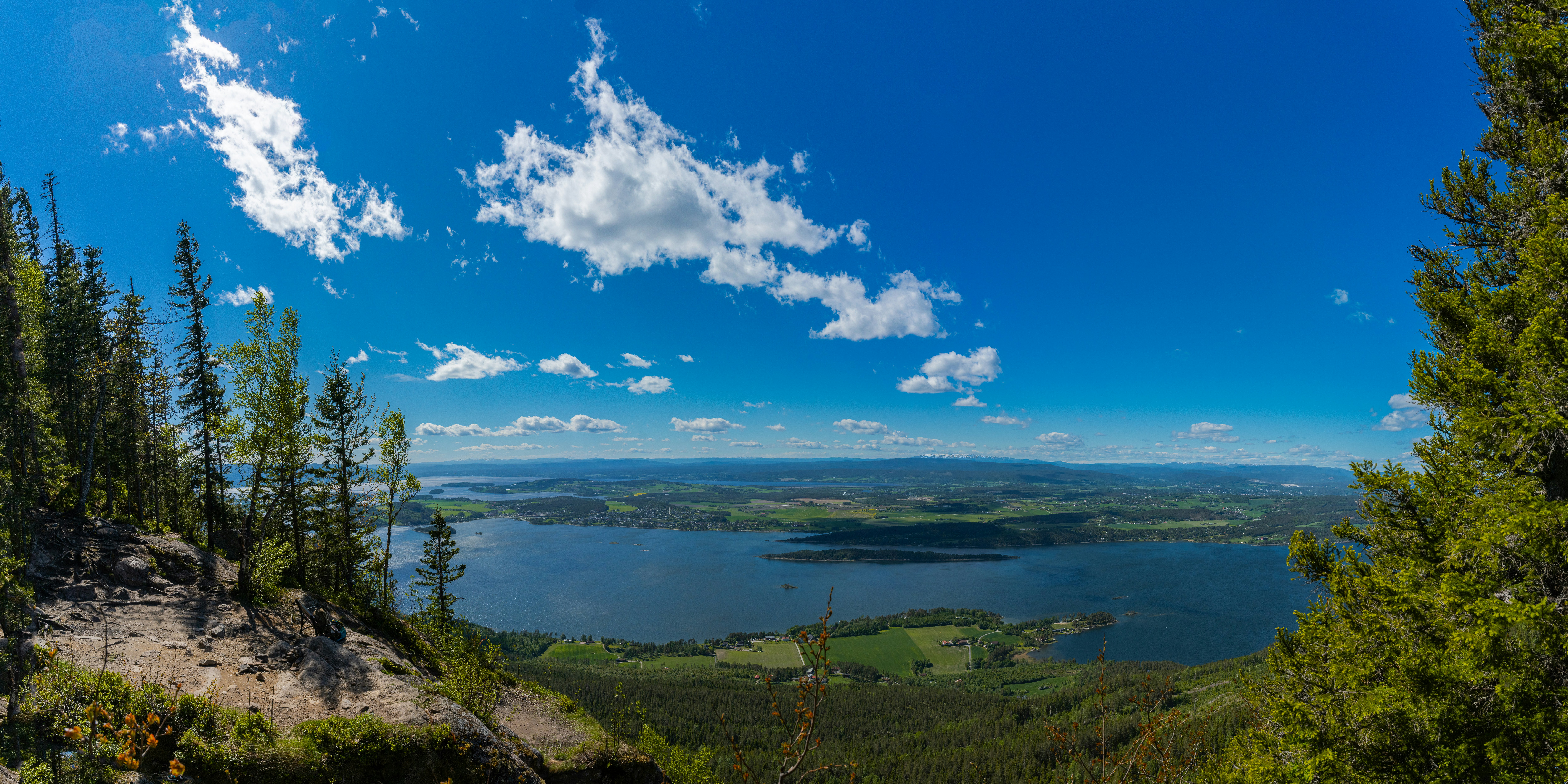 Serene lakeside panorama from a sunlit hillside
