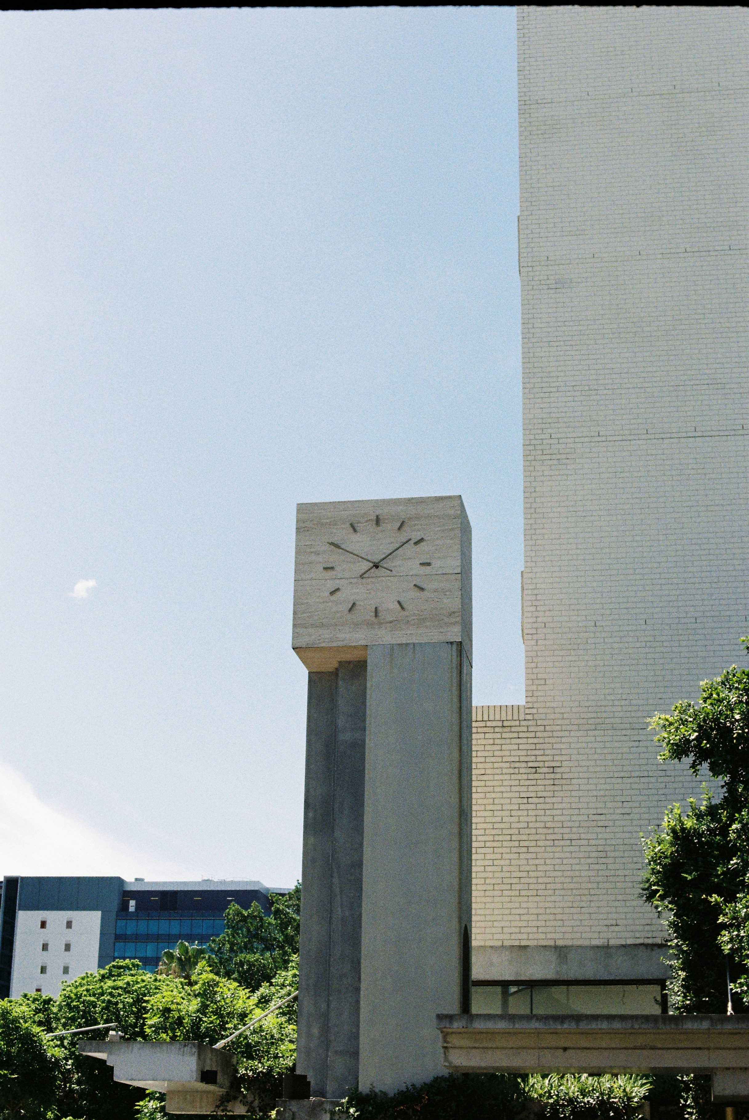 Vertical Clocktower Amidst Modern Facades