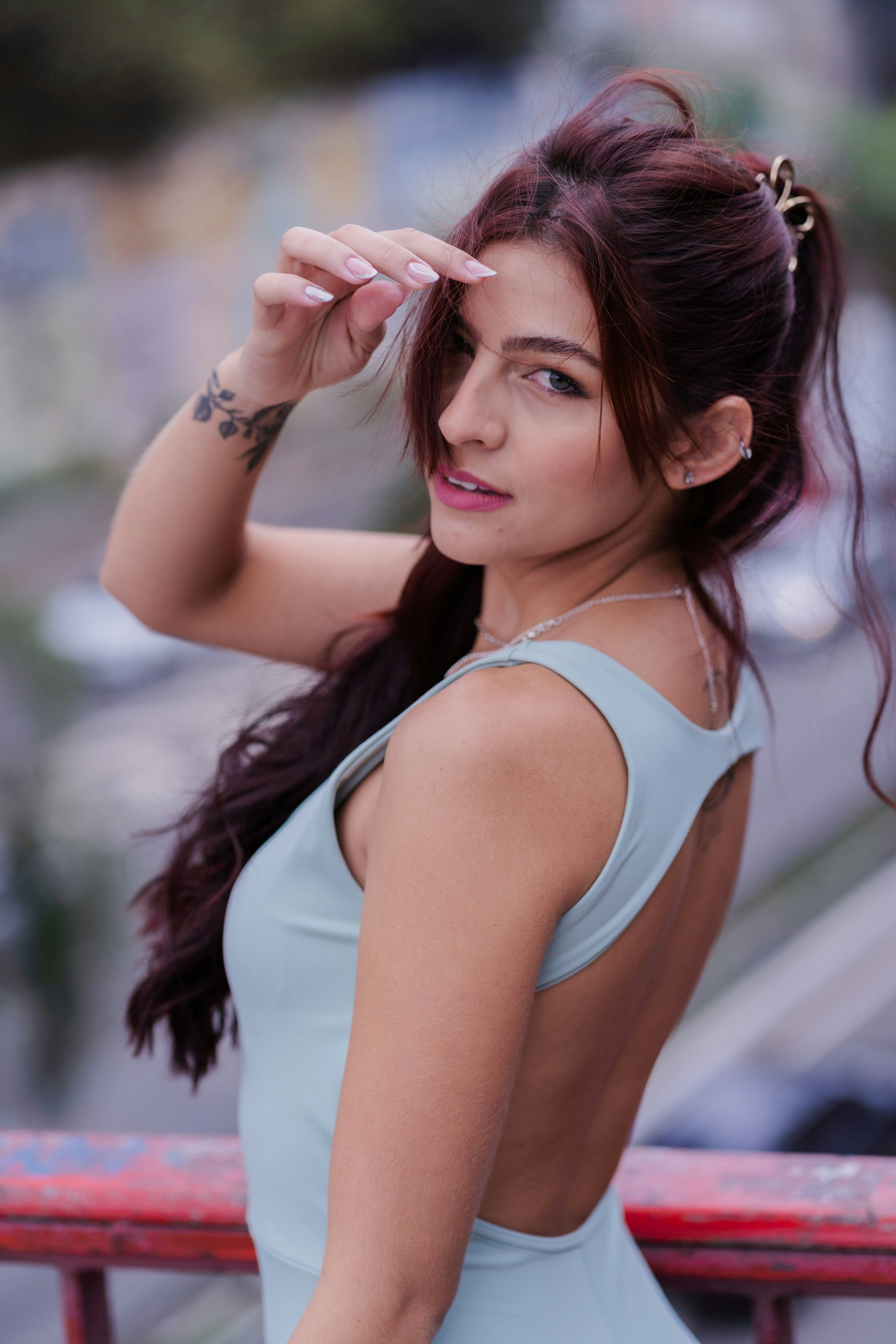 Gaze on the Terrace: Soft Portrait with a Hint of Red