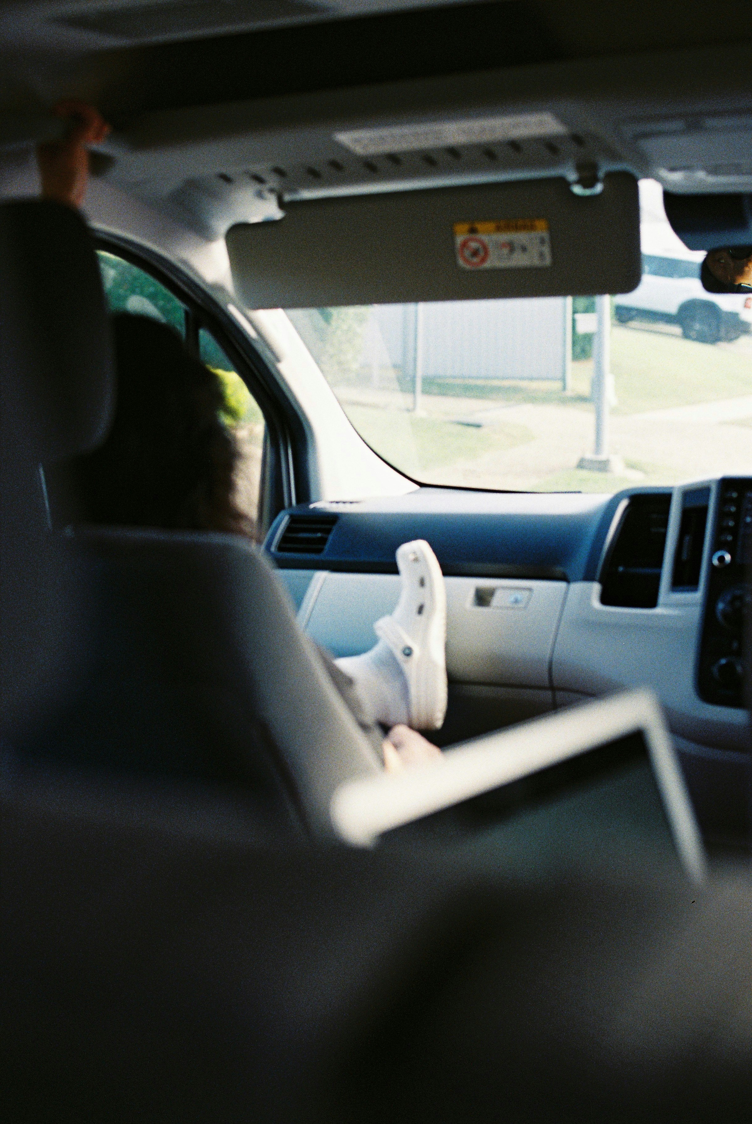 Passenger's Feet on the Dashboard: A Low‑Angle Inside View