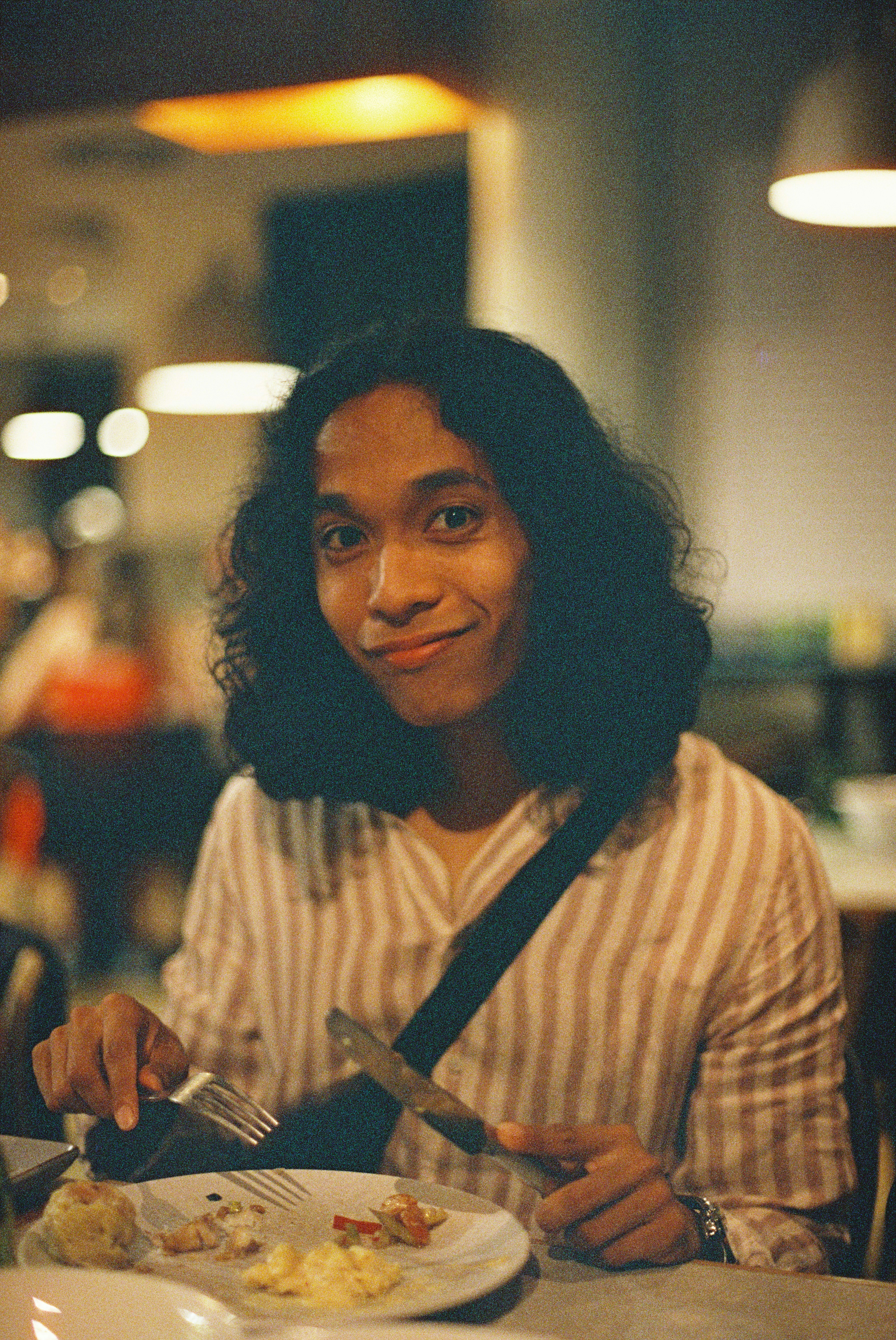 Softly lit confidant: a smiling diner in warm tones