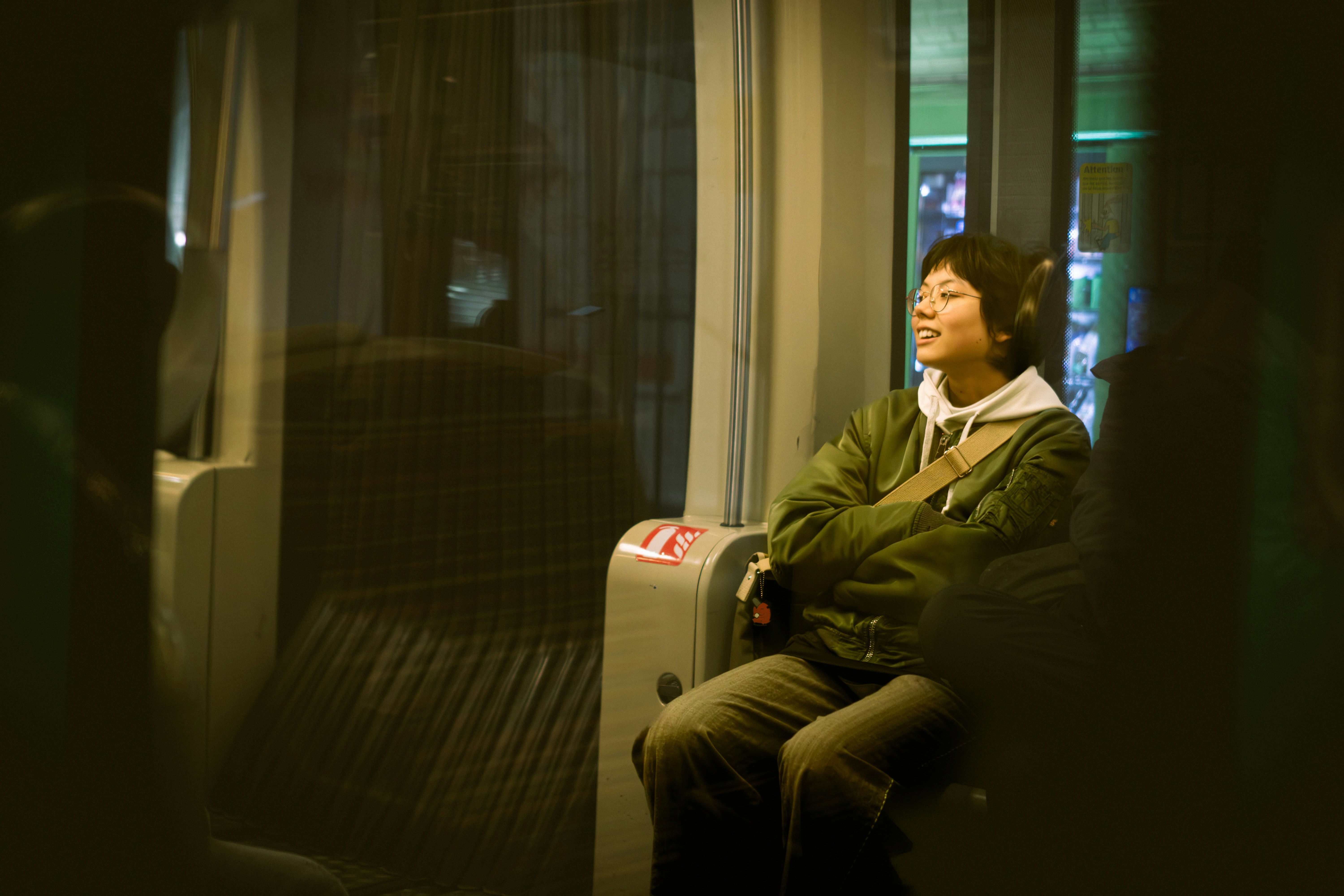 Passenger in Transit: A Quiet Moment Amid Windowed Light