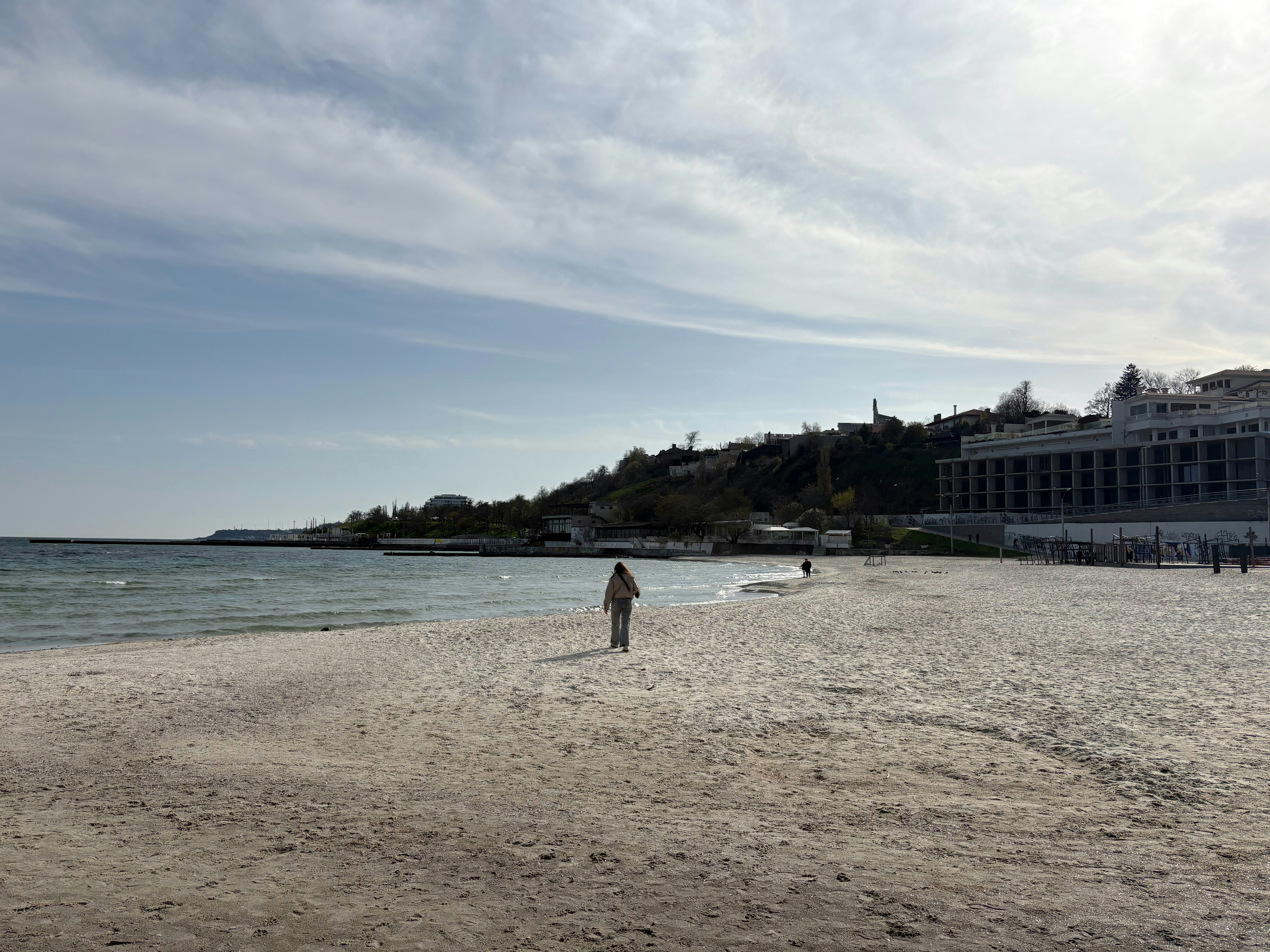 Solo Seeker on a Quiet Seaside Sand