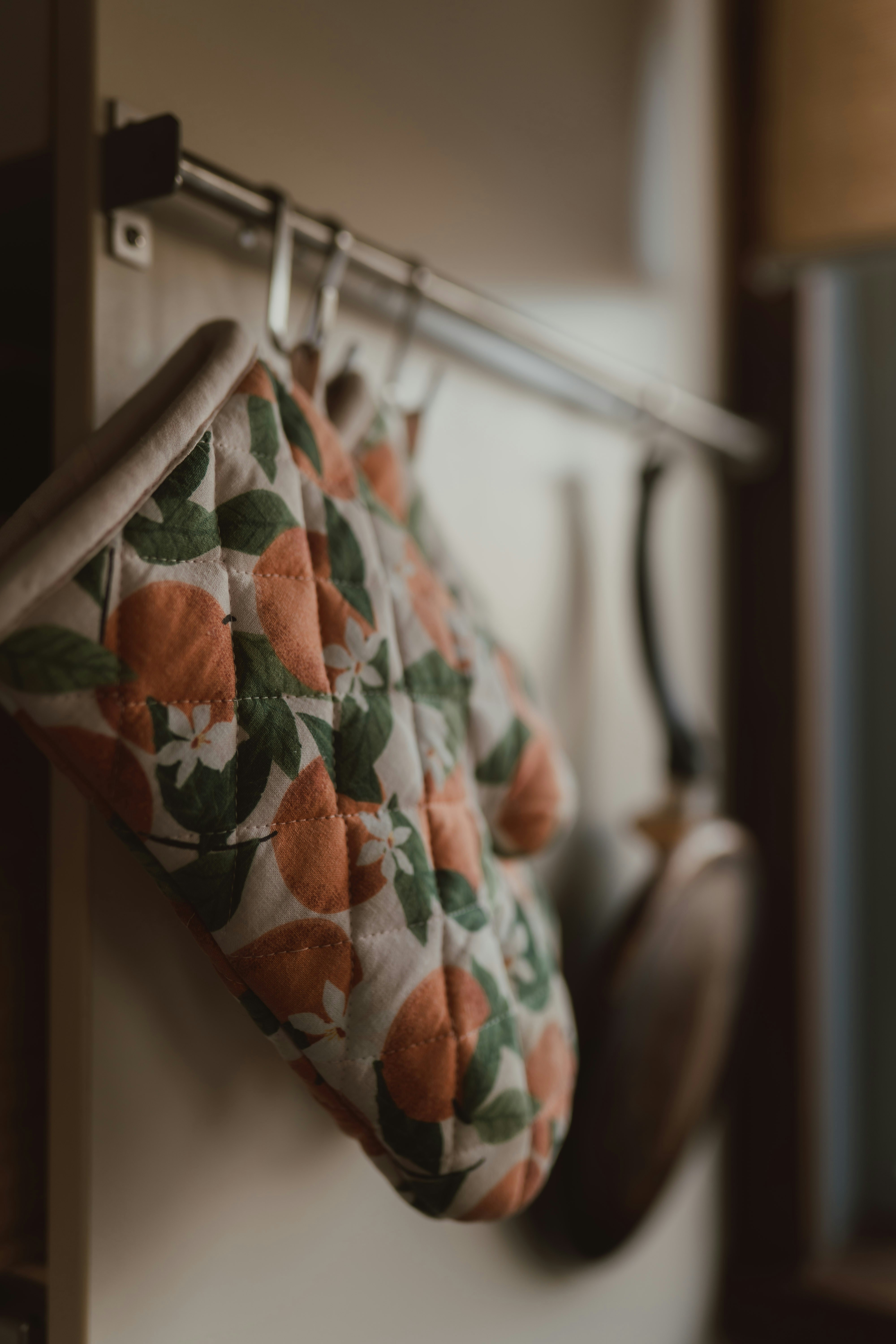 Quilted Oven Mitts Lean Against a Pantry Hook