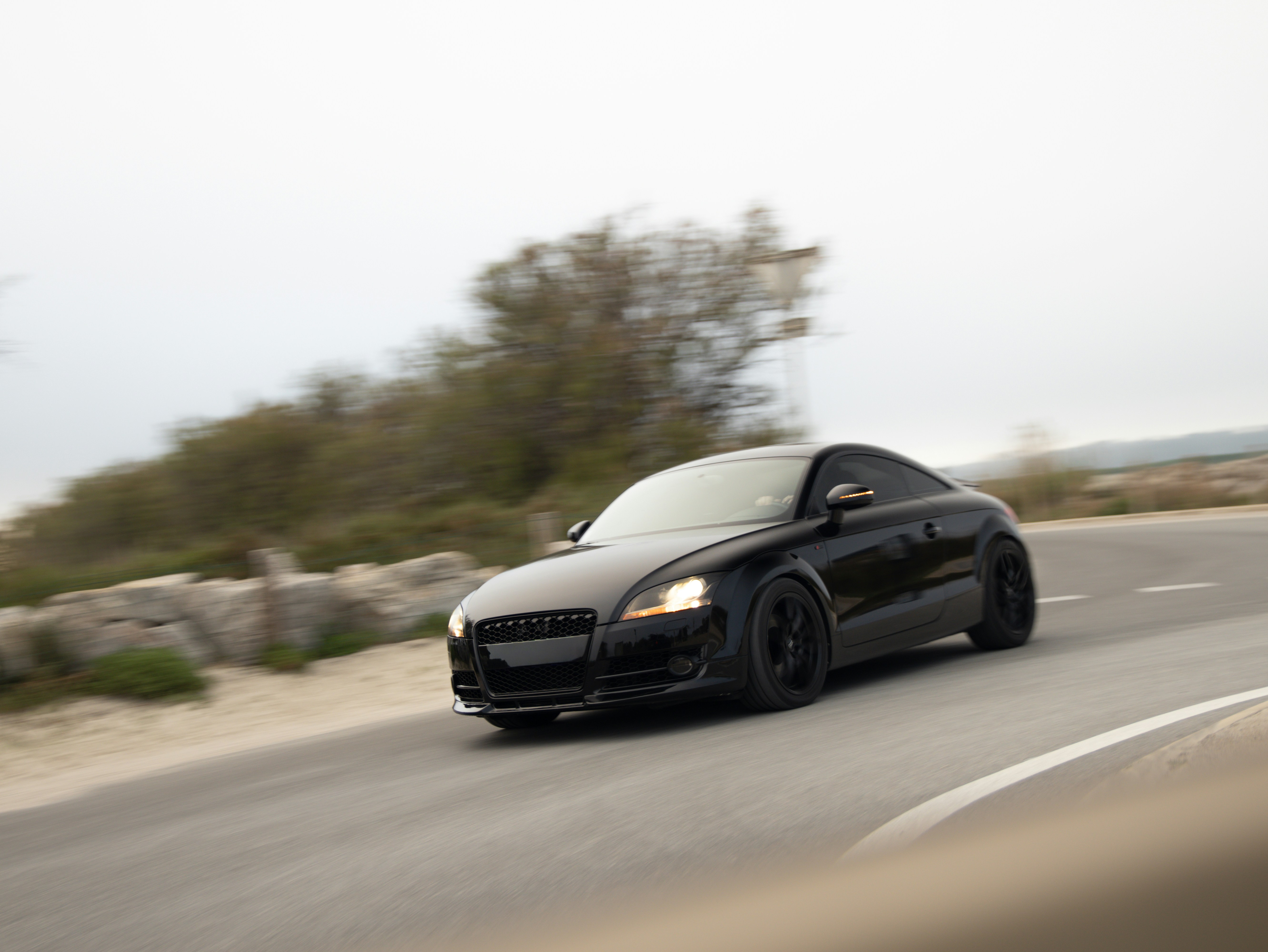 Mid‑Motion Noir: A Black Sports Car in Blur on the Open Road