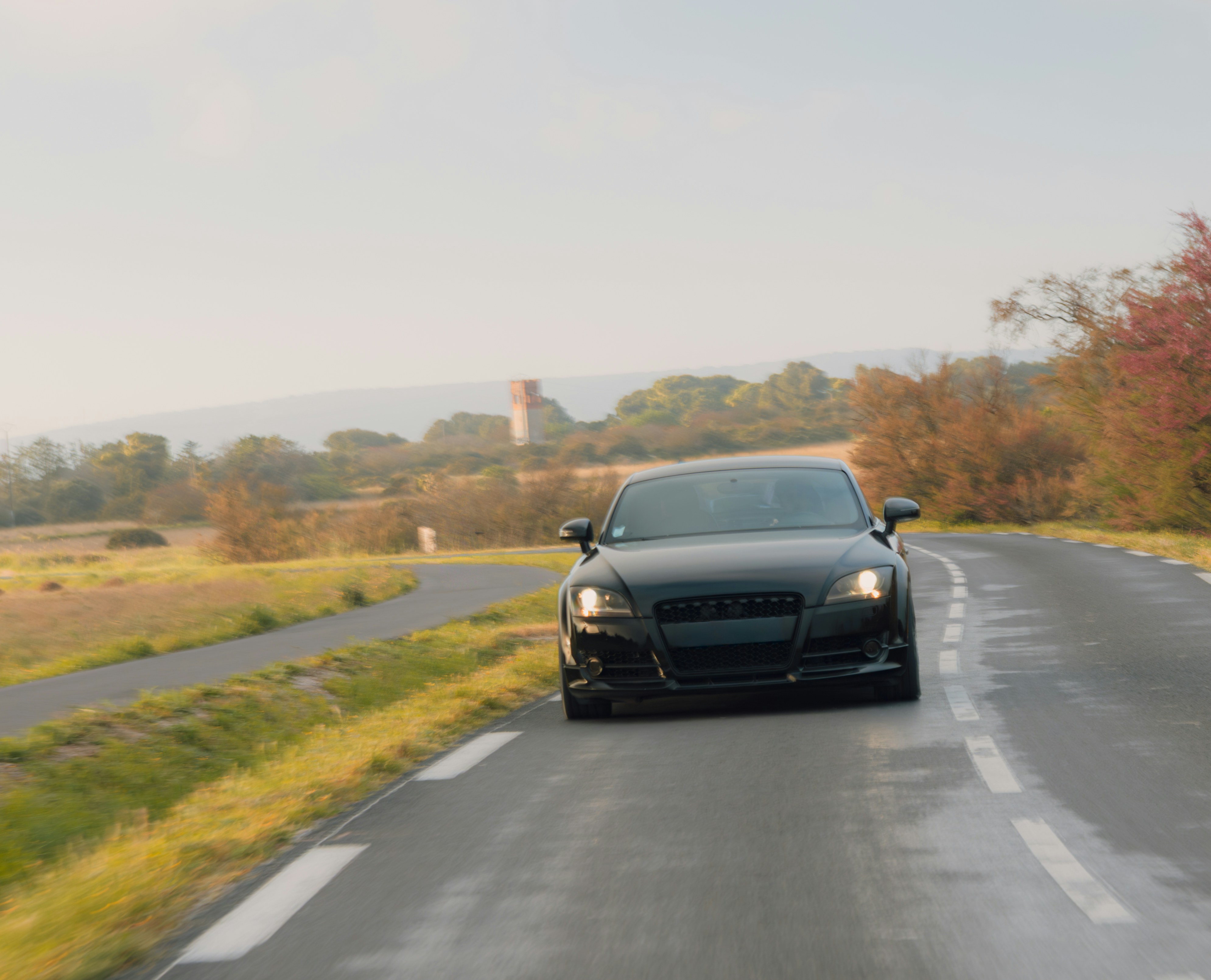 Midnight Drive: A Black Coupe Cutting Through a Quiet Countryside Road
