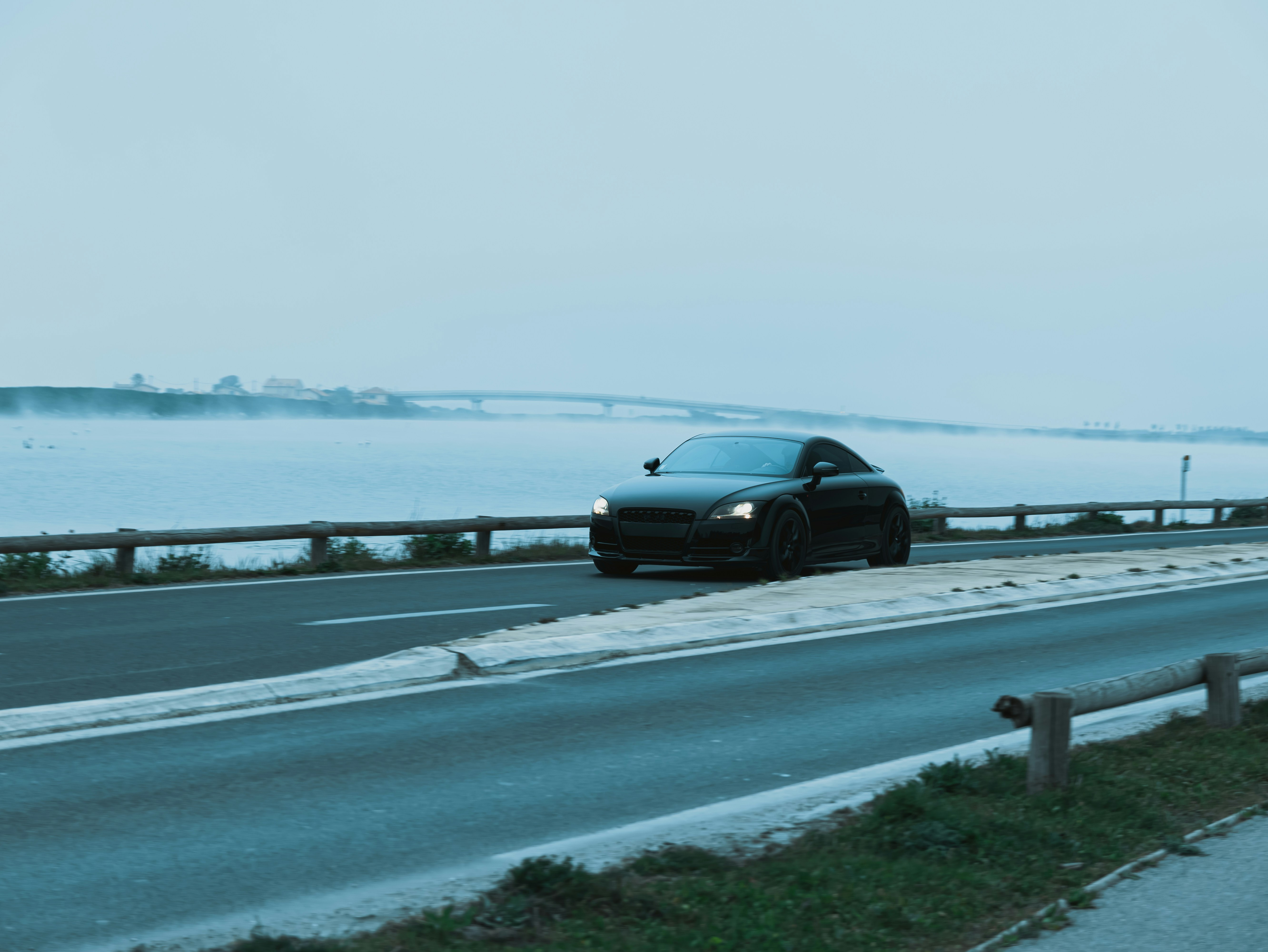 Low-Tempo Ride: A Convertible Stands Sent on a Quiet Coastal Road