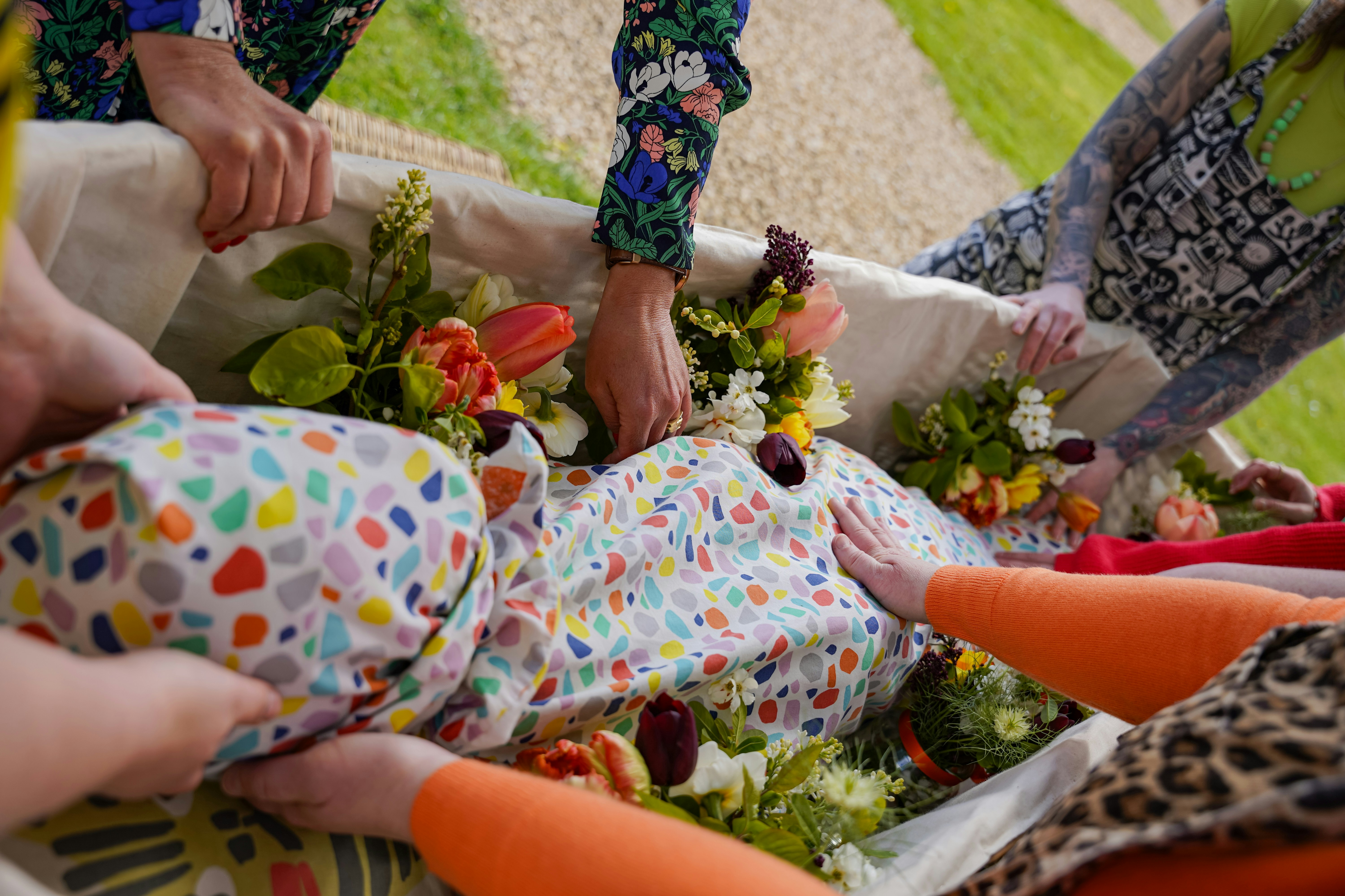 People Reach into a Floral-Lined Cloth Banner Ceremony
