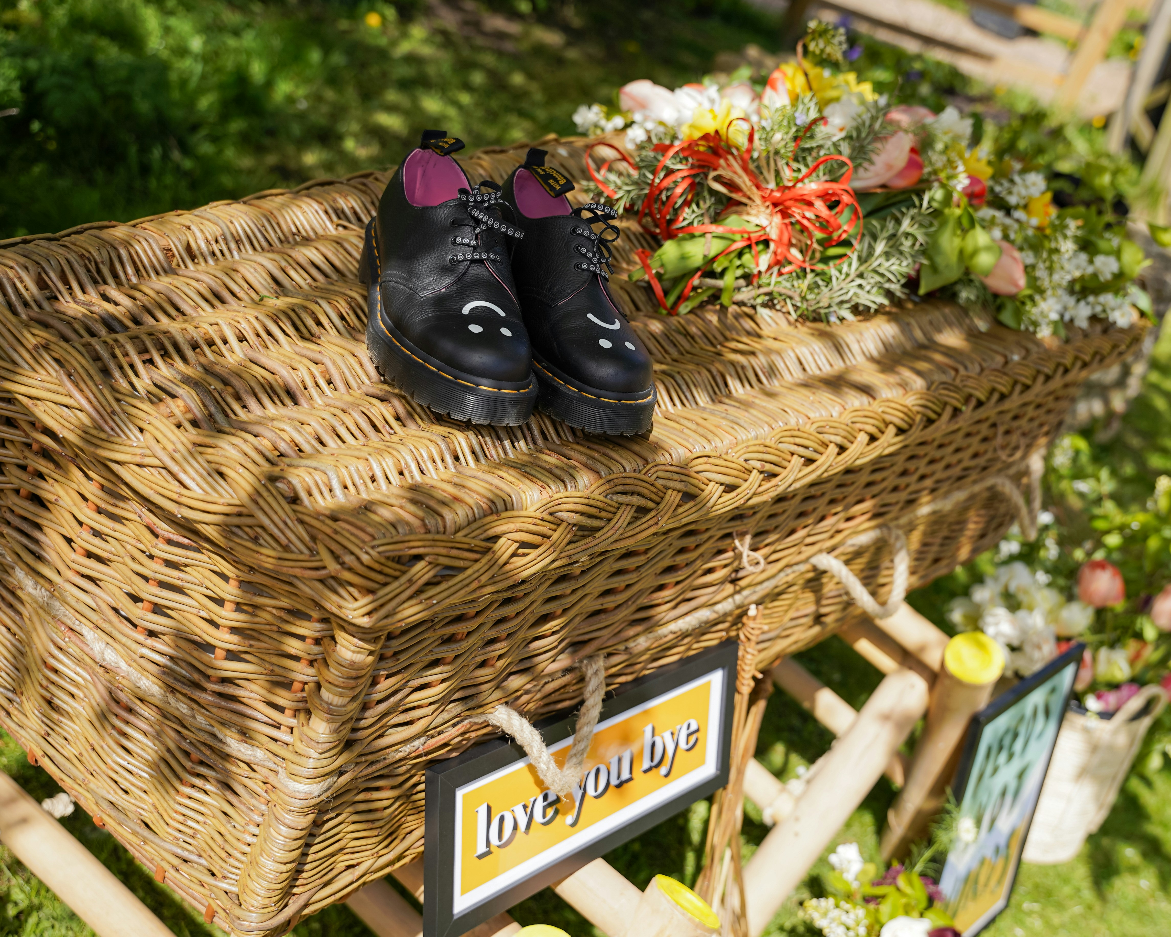 A Quiet Farewell: Black Mary Jane Shoes Rest on a Floral Funeral Basket