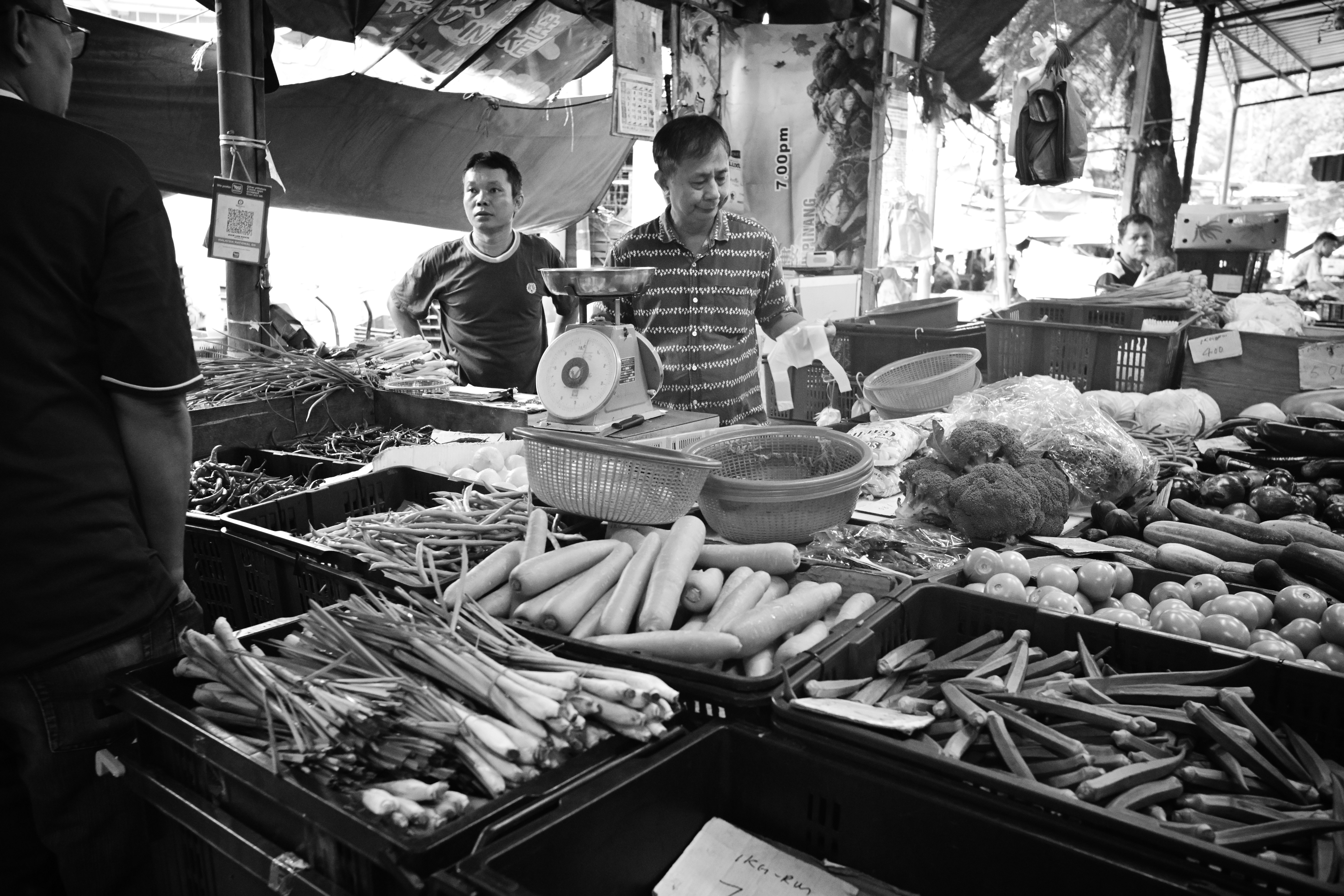 Market Stand in Black and White: Fresh Produce and Quiet Tension