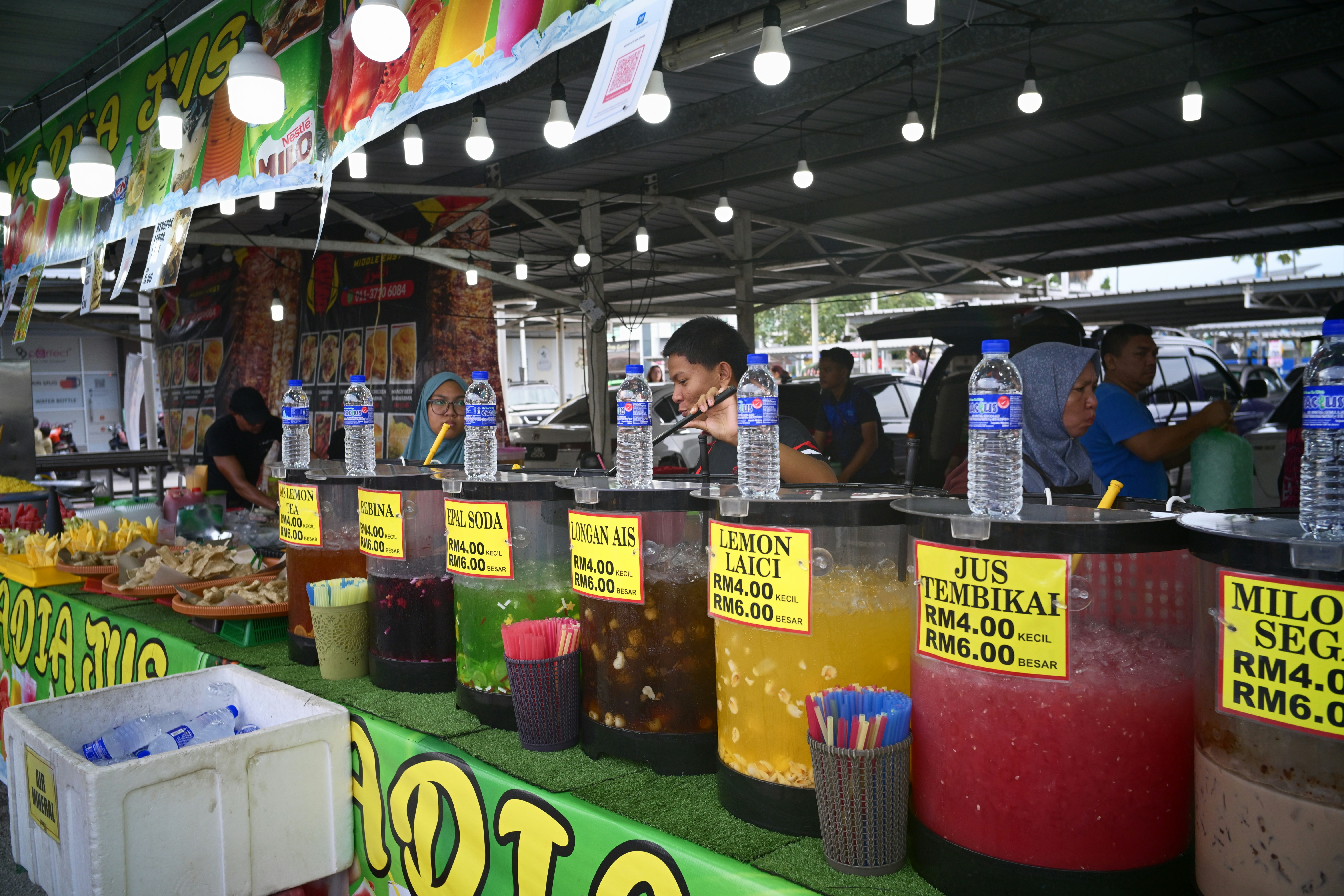 Colorful Thai Street Drink Stand with Stainless Jugs and Bottled Gelatin Eyes