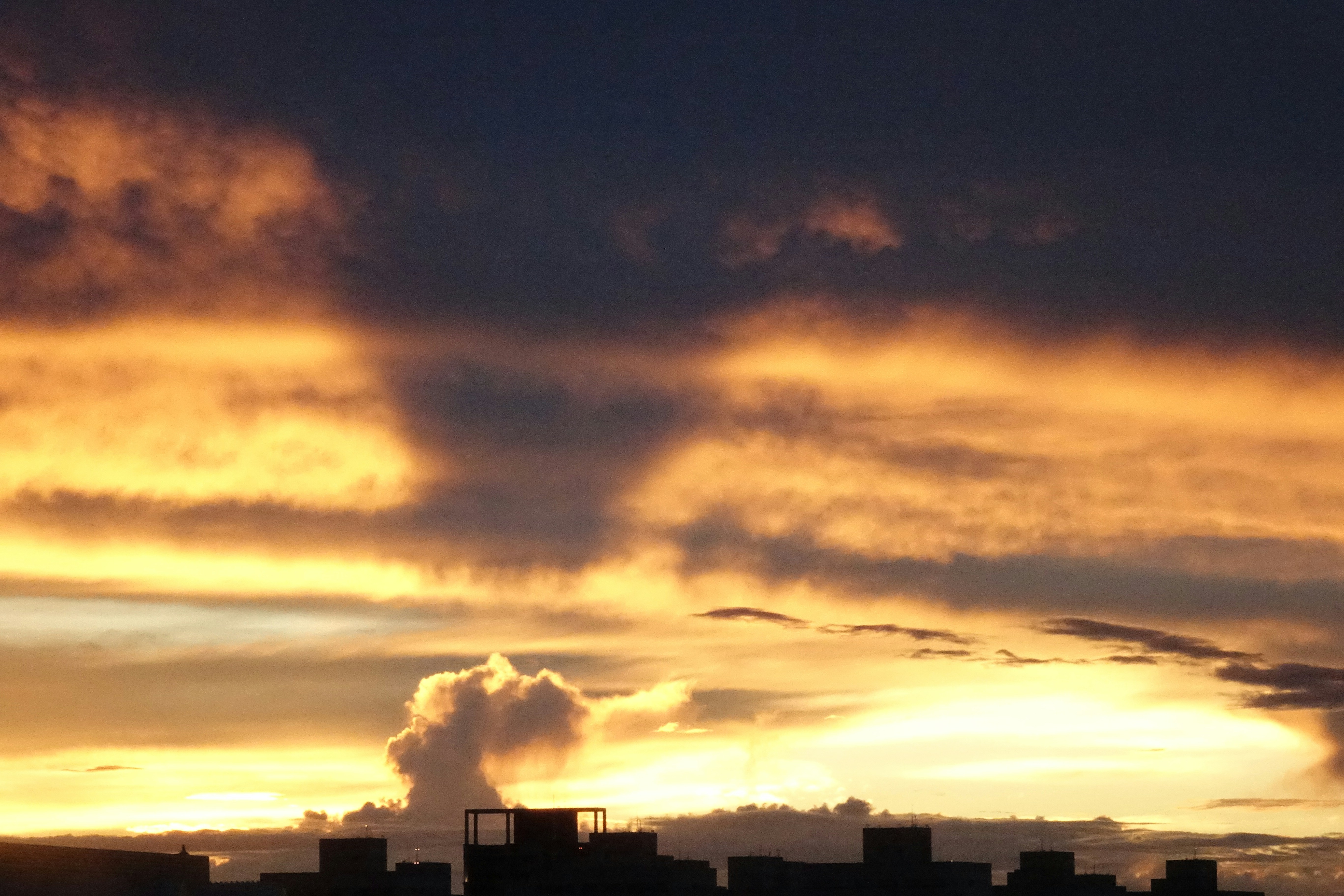 Sunset Silhouette Over a Quiet City Horizon