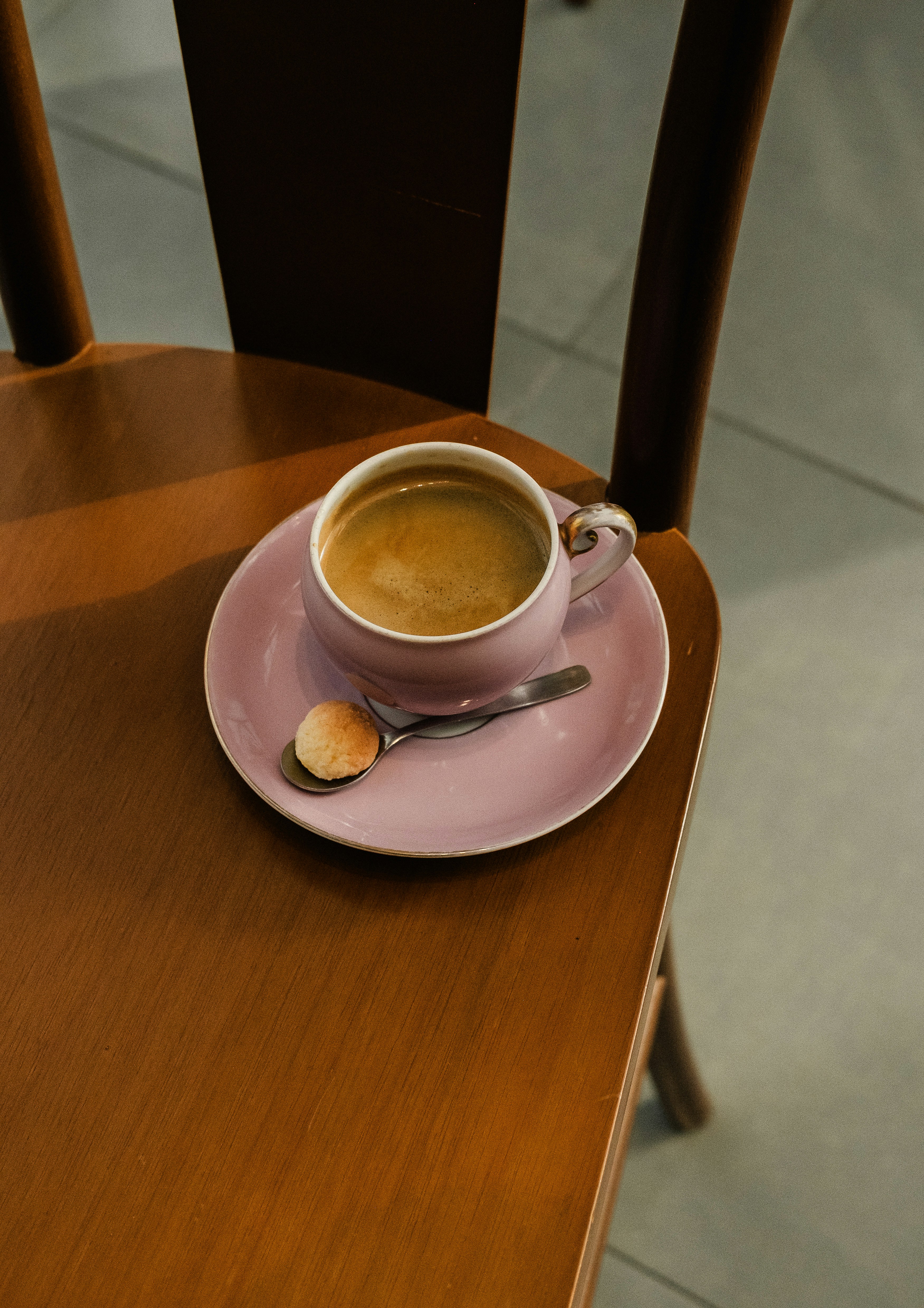 A Quiet Moment: Pink Cup and Spoon on a Café Table