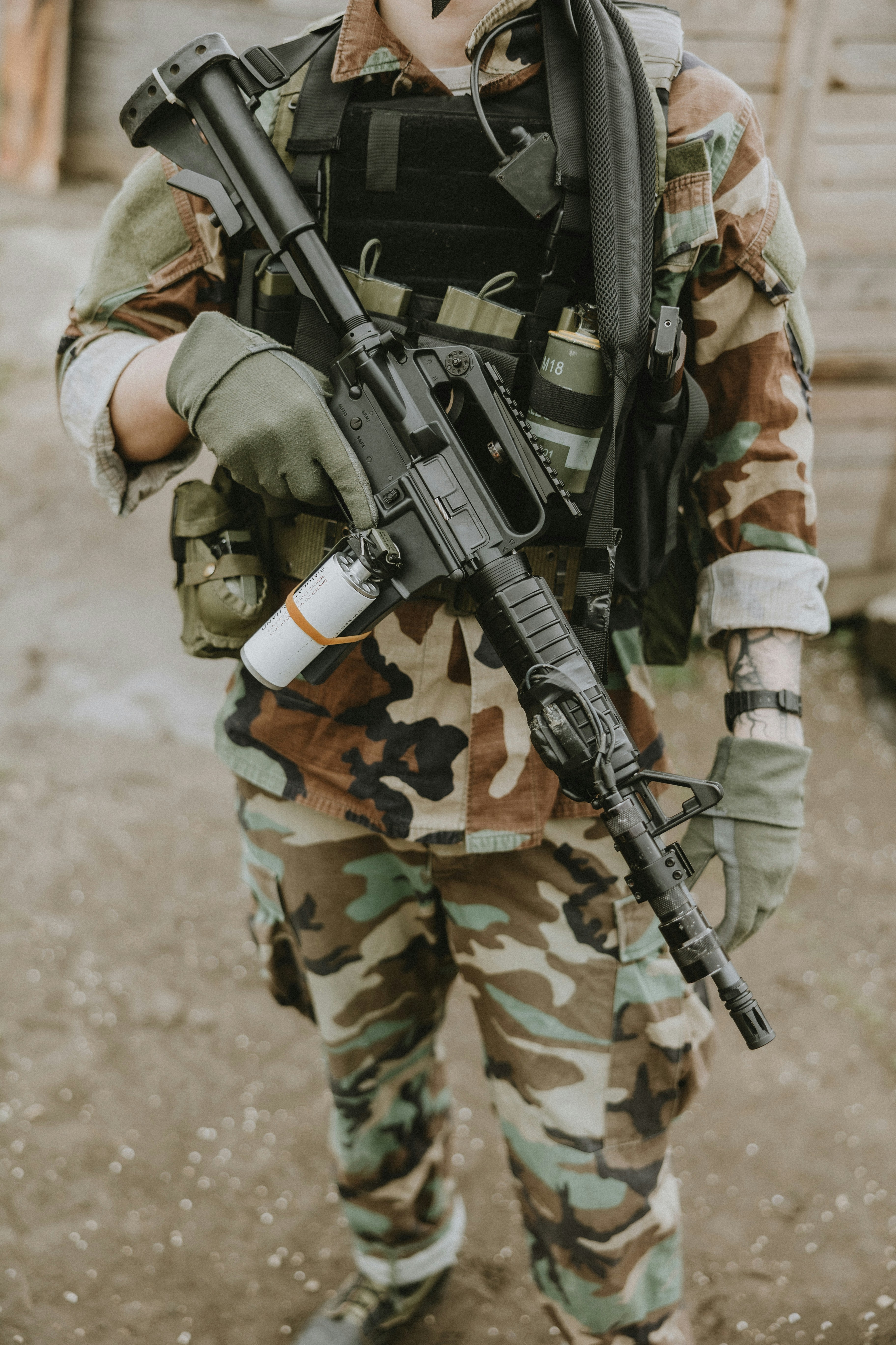 Camouflaged Warrior with Rifle and Gear