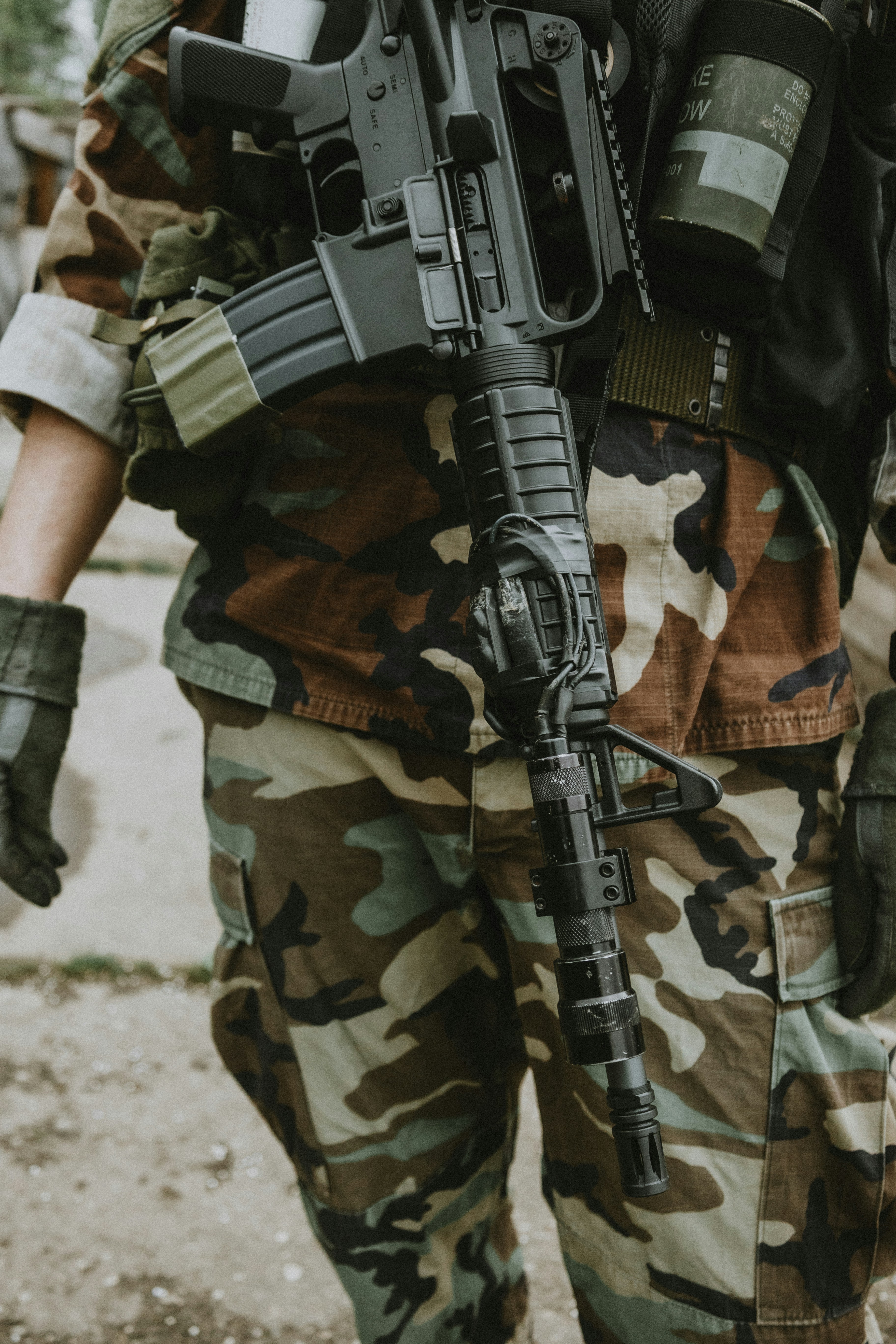 Camouflage Resolve: Close-Up of a Rifle-Toting Soldier in Field Gear