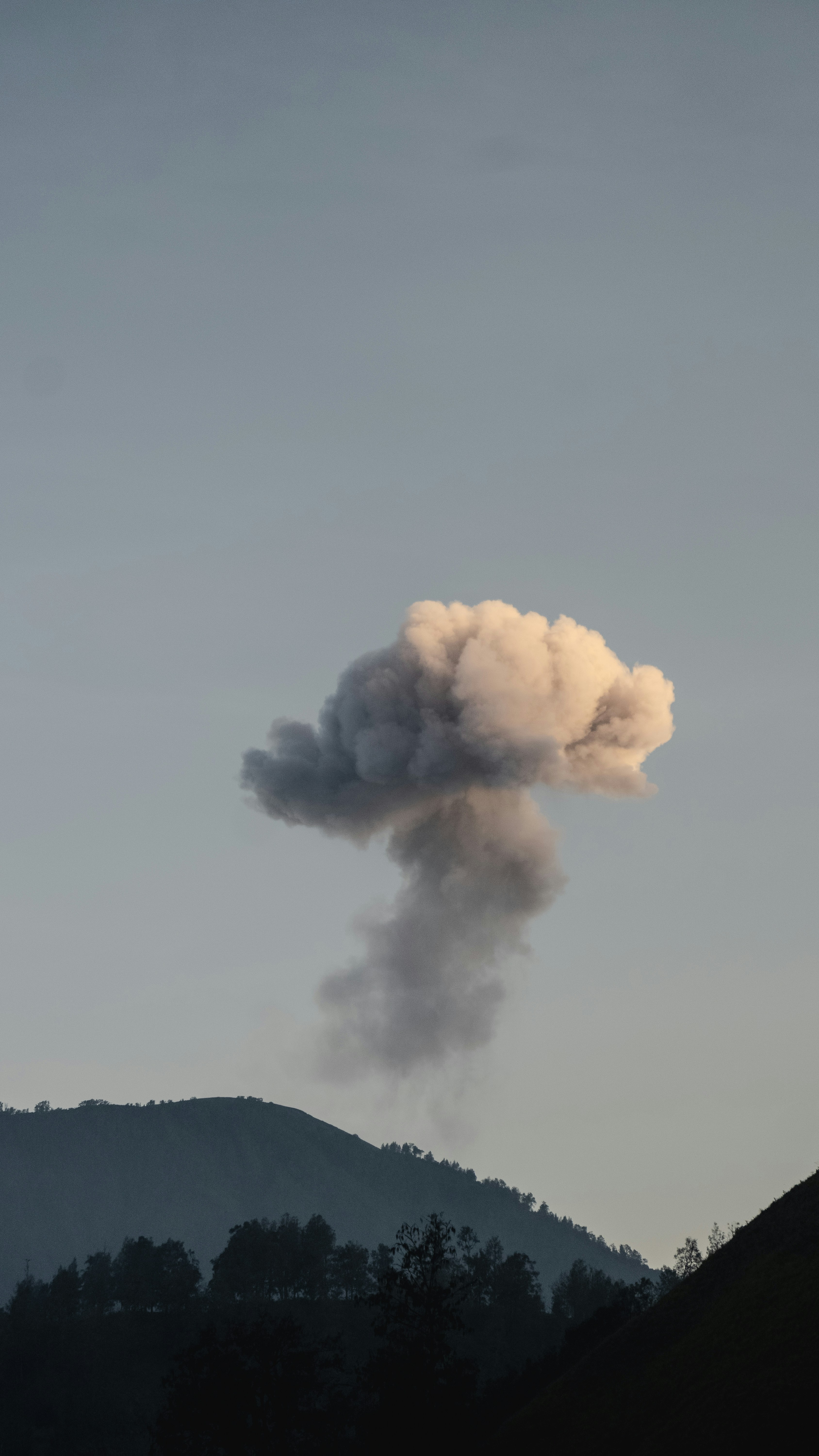 Cloud of Impact: Dawn Smoke Rises Over Ridge