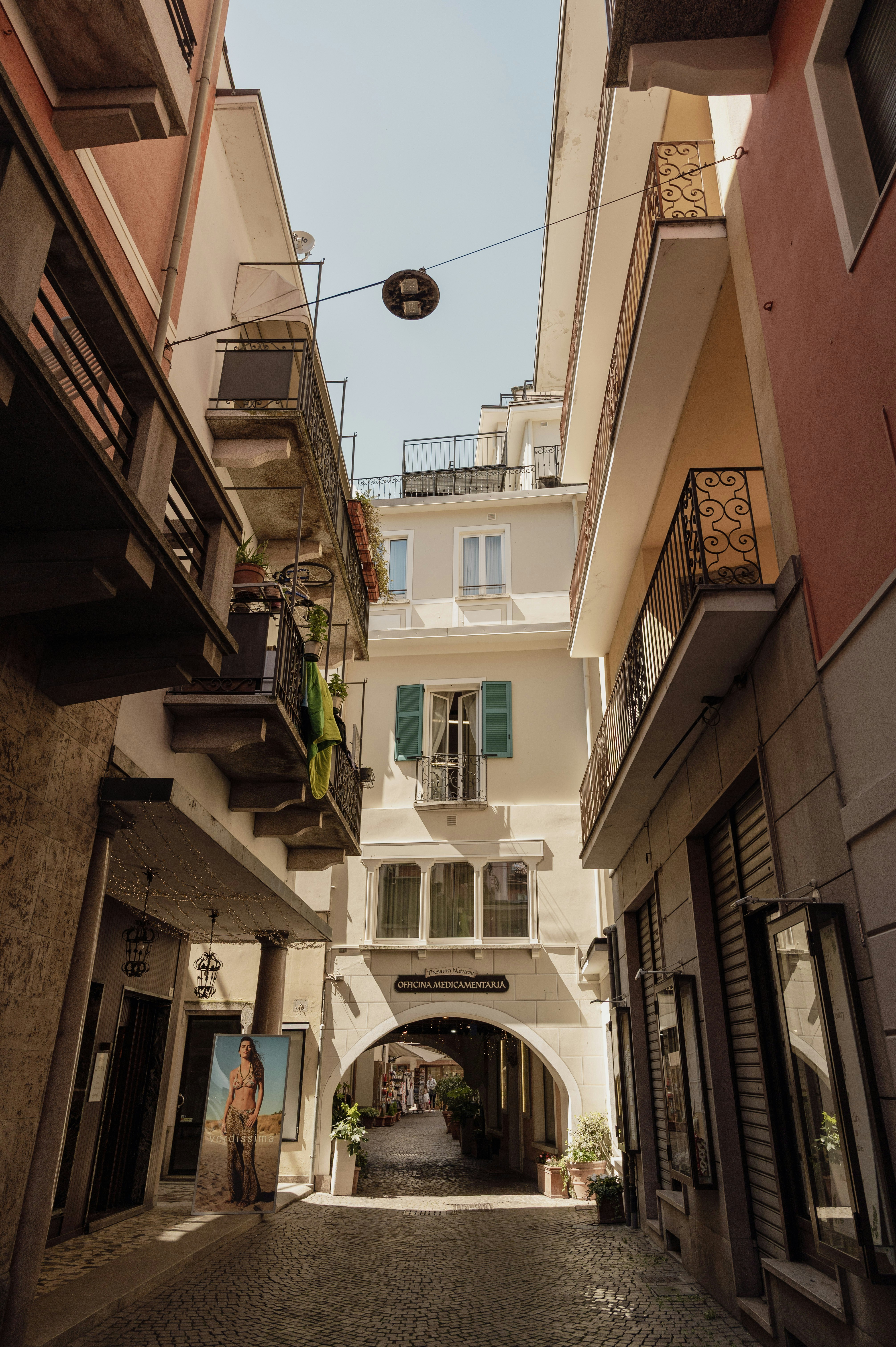 Archway into the sunlit alley: a Mediterranean arcade