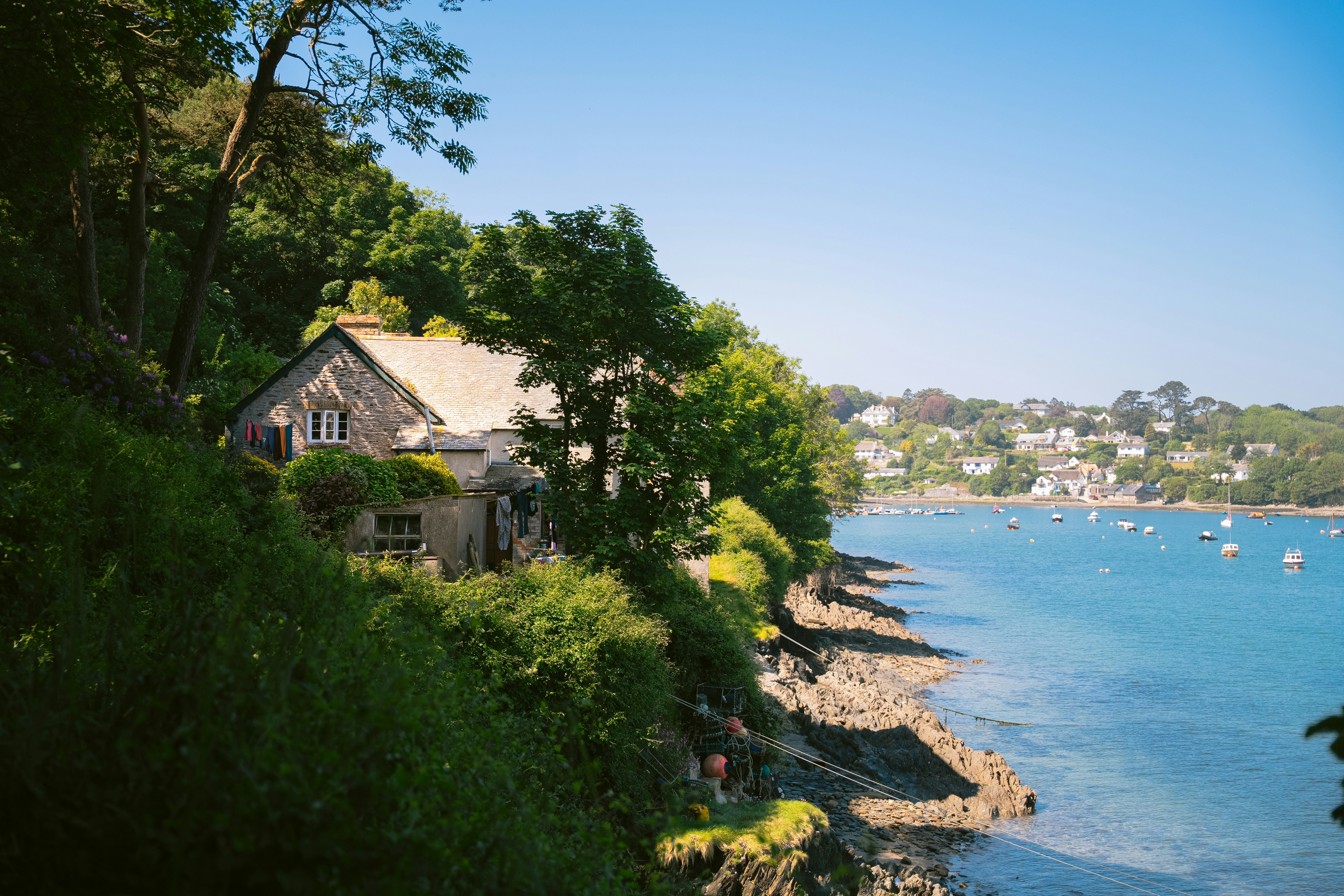 Quaint cliffside cottage basking in coastal afternoon light