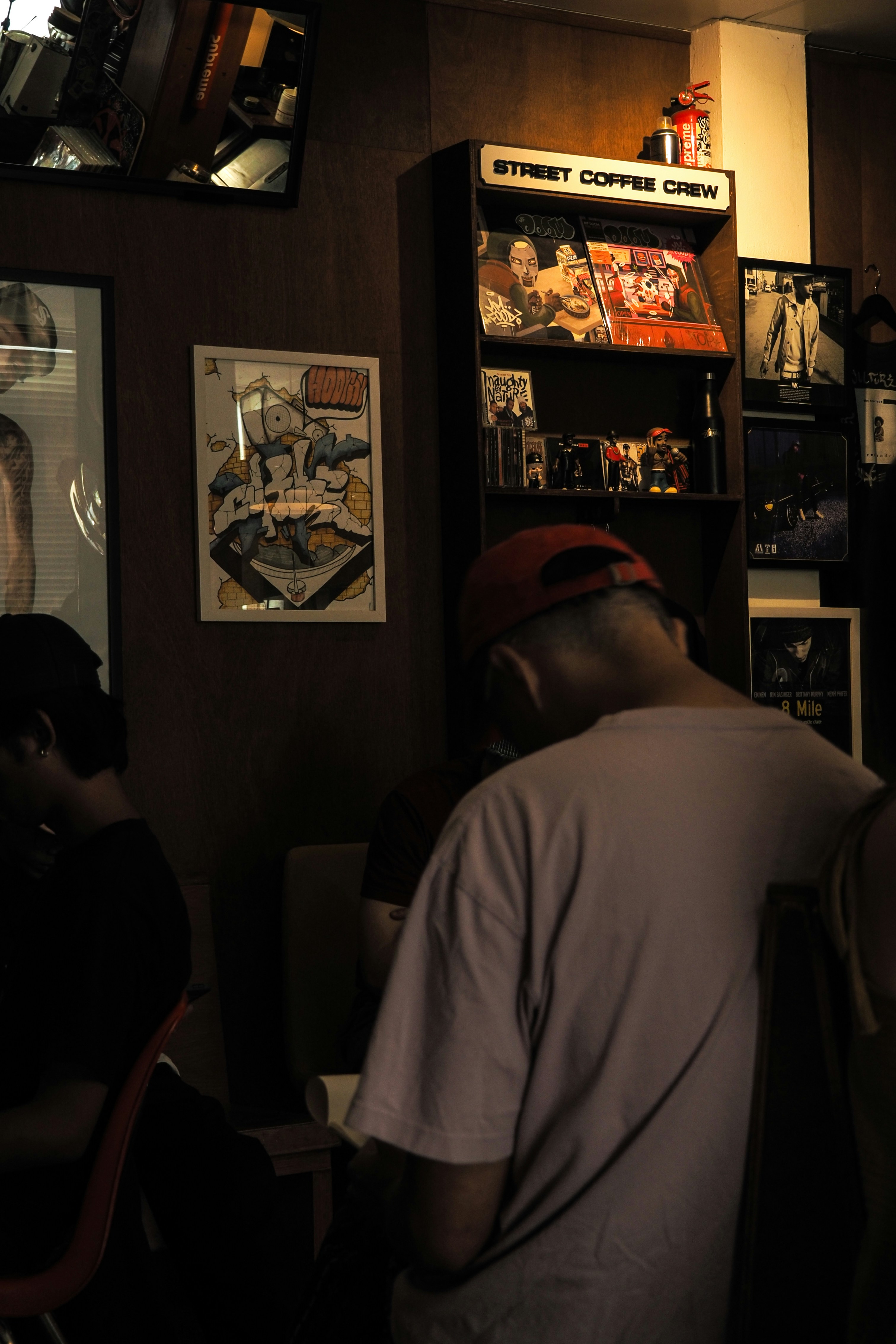 Shadowed Café: A Quiet Corner Amid Street Art and Memorabilia