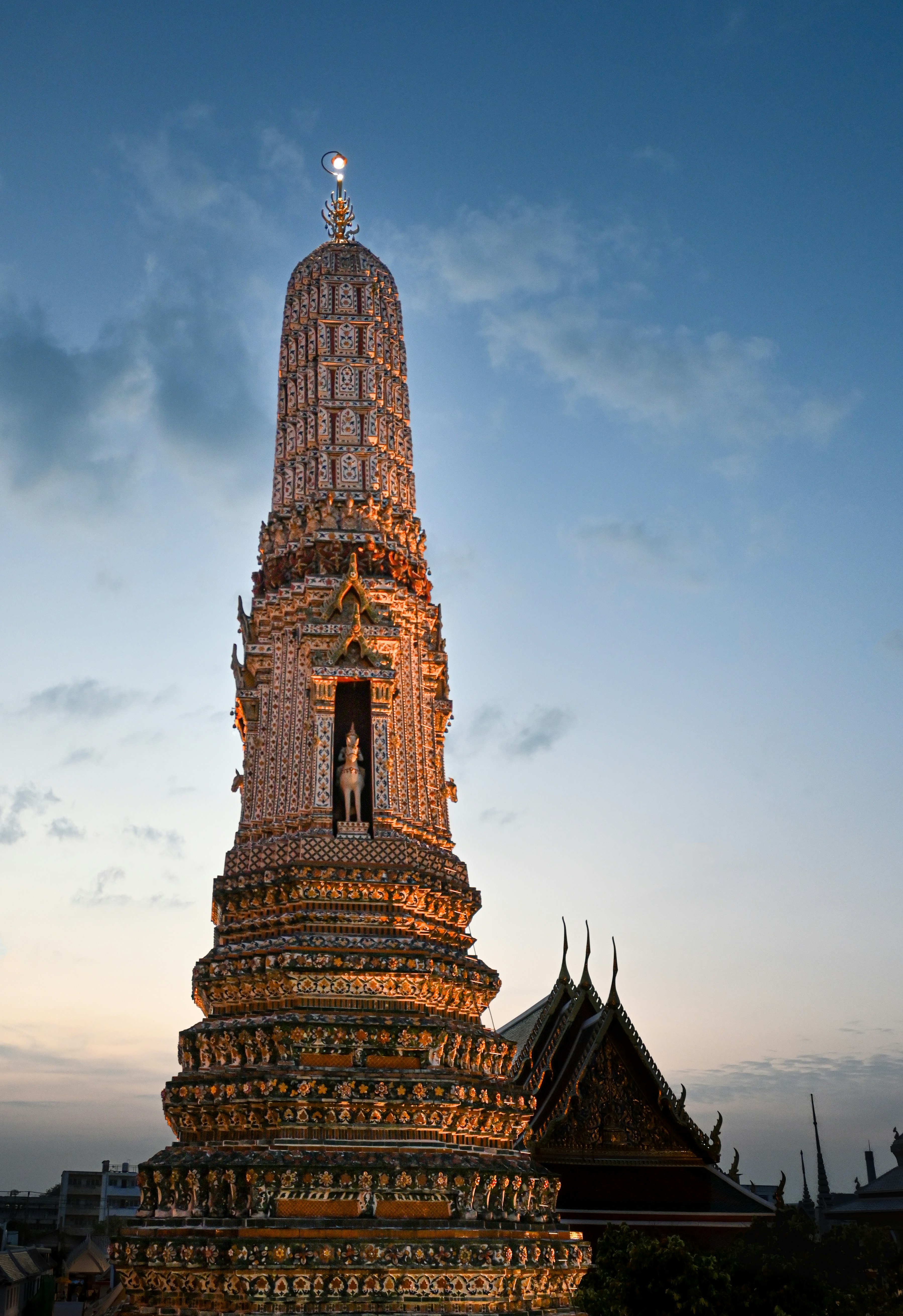 Terra Cotta Spire at Dusk: A Towering Temple Ornament Glowing in Evening Light