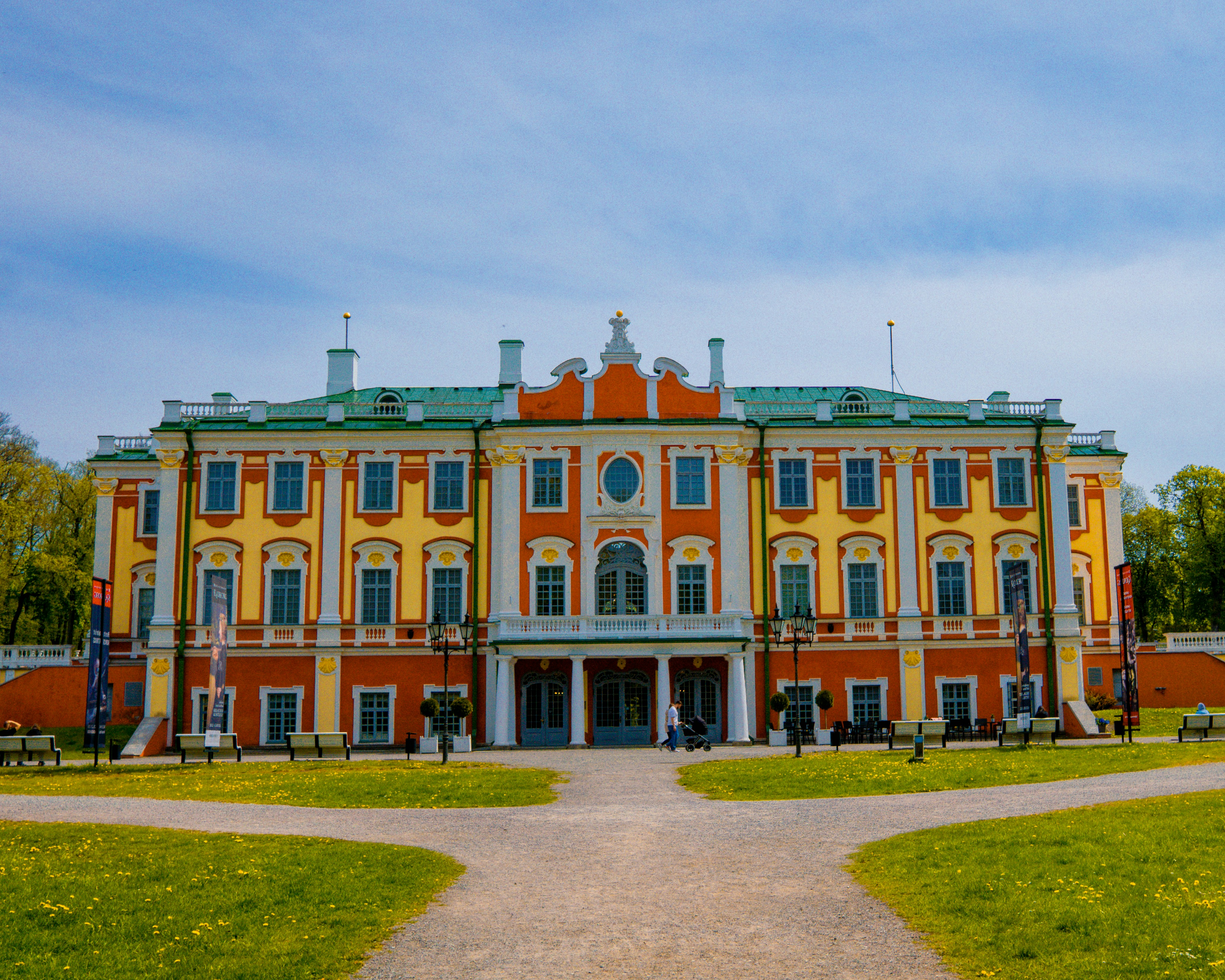 Symmetrical Baroque Revival: A Painted Facade Framed by Elm Shade