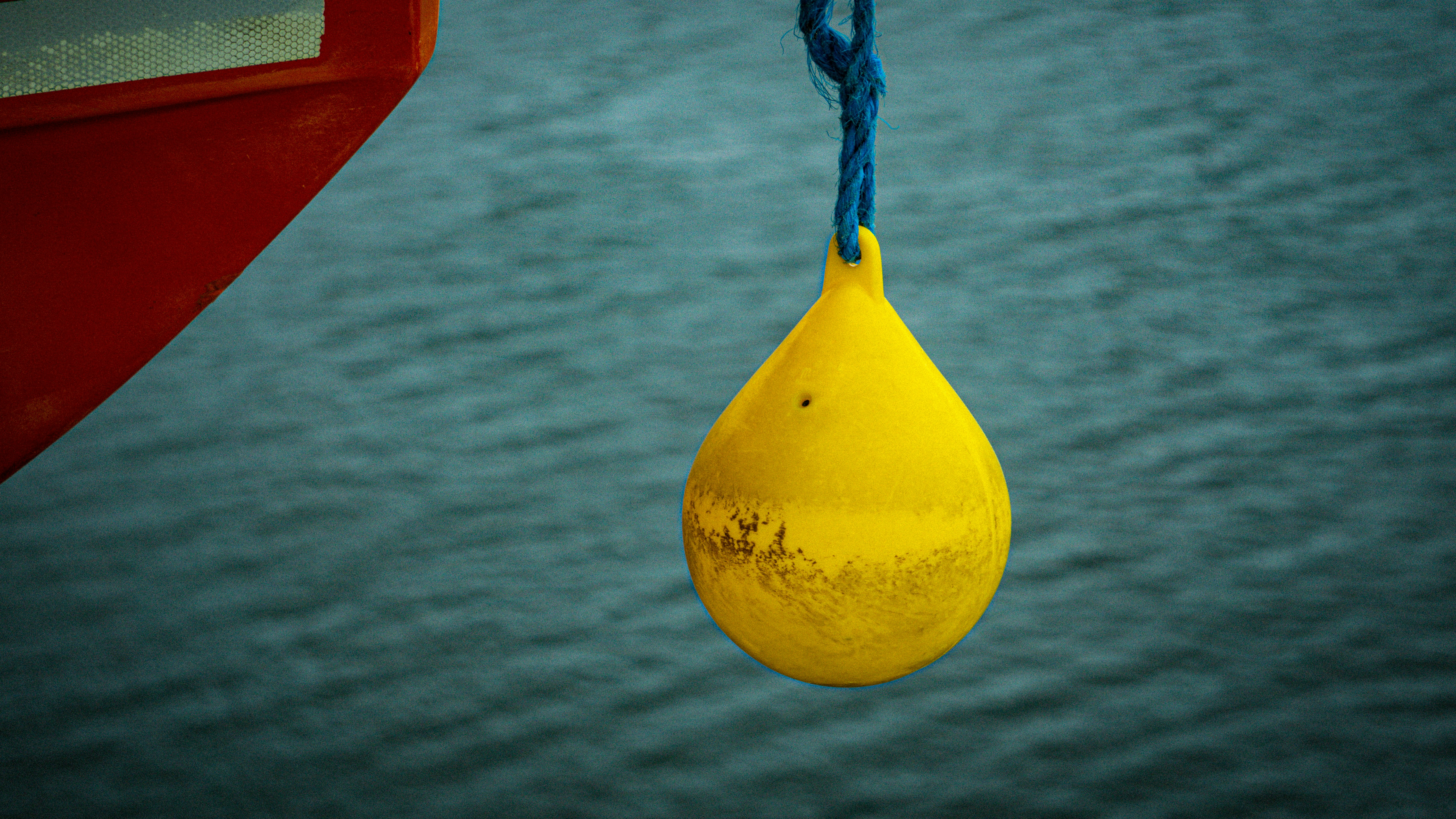 Rope-Tethered Buoy Hovering Above Quiet Blue