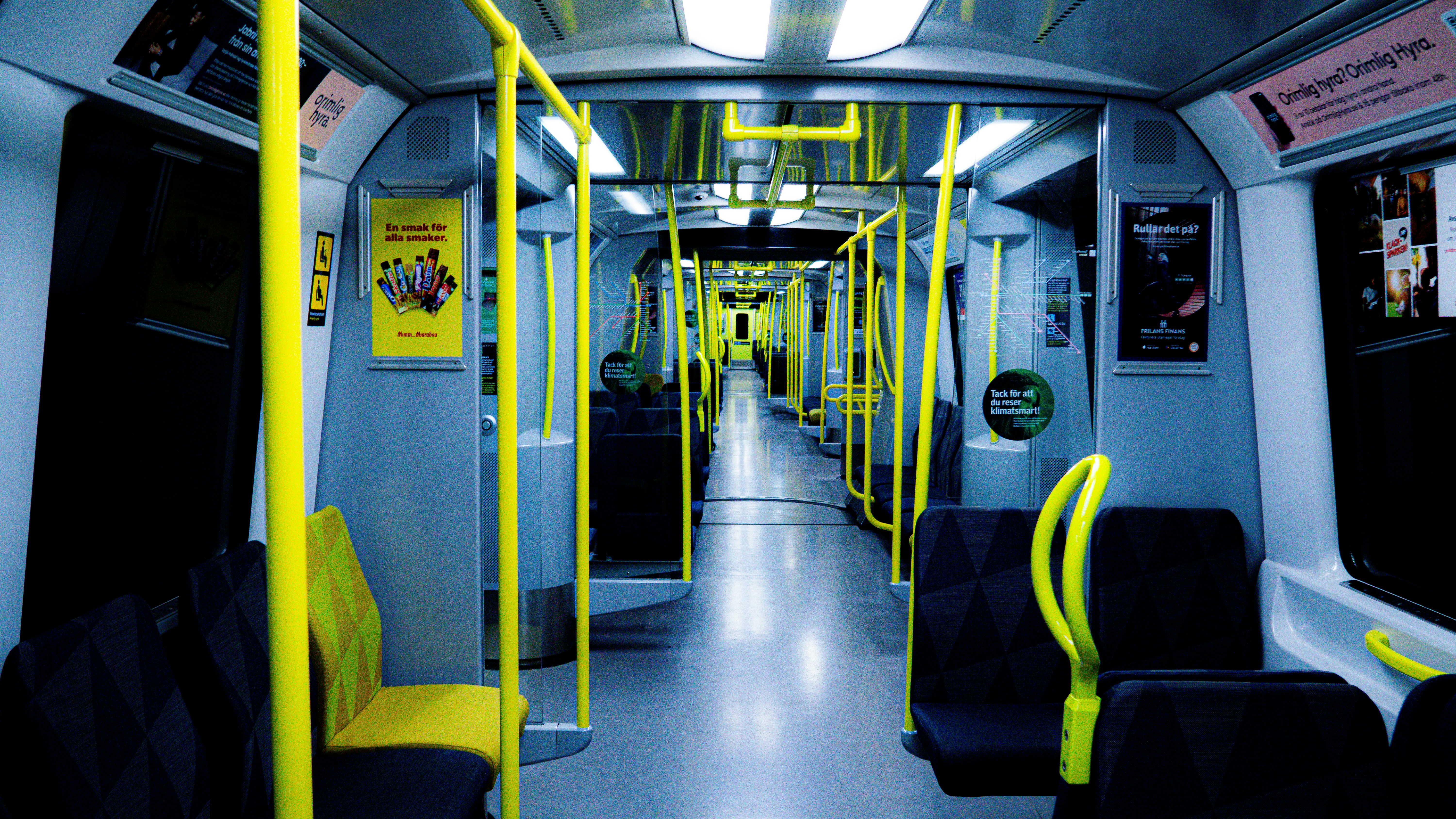 Symmetry in Motion: A Quiet Descent Through a Yellow-Railed Subway Car
