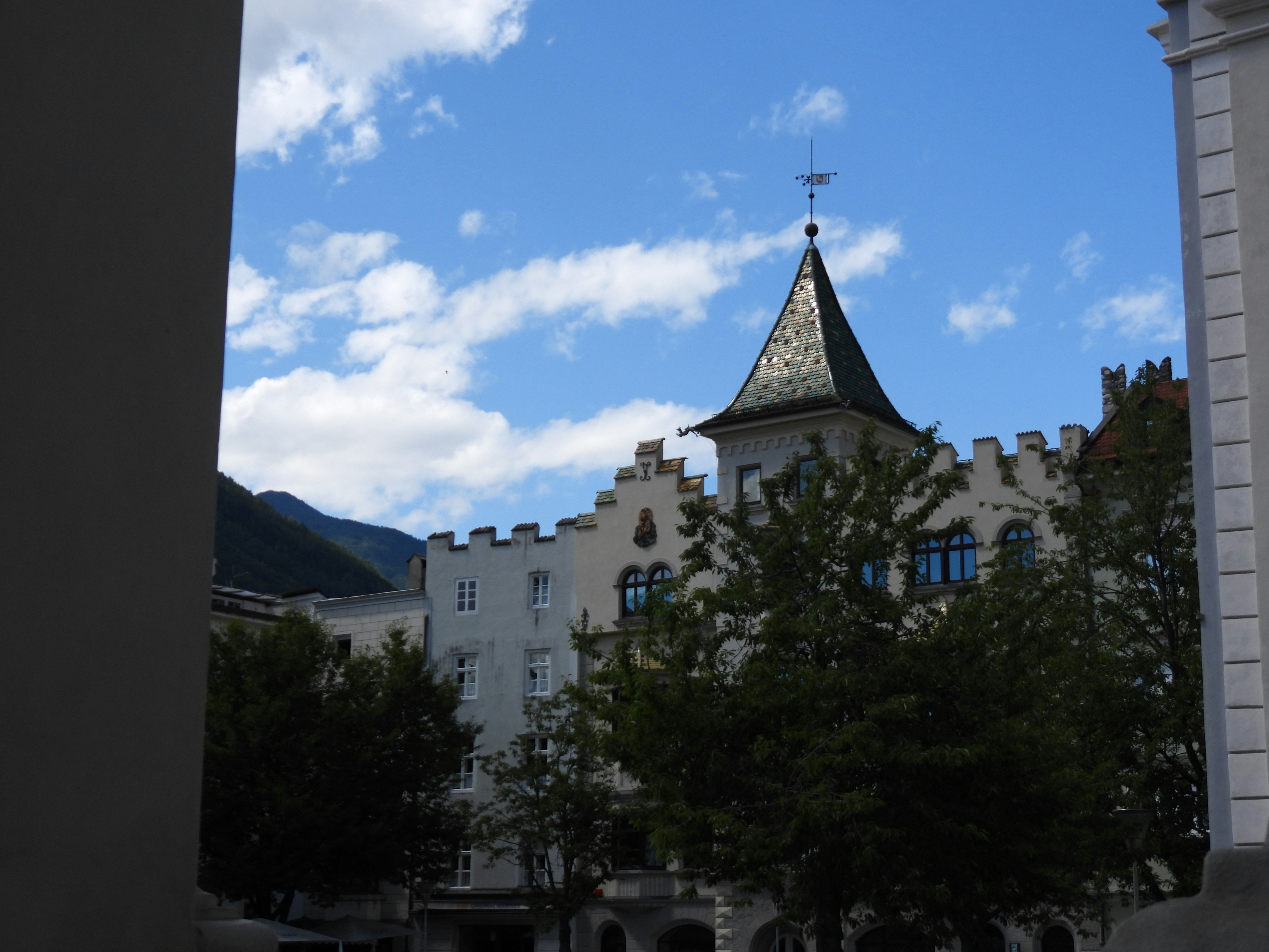 Castle silhouette under a bright alpine sky