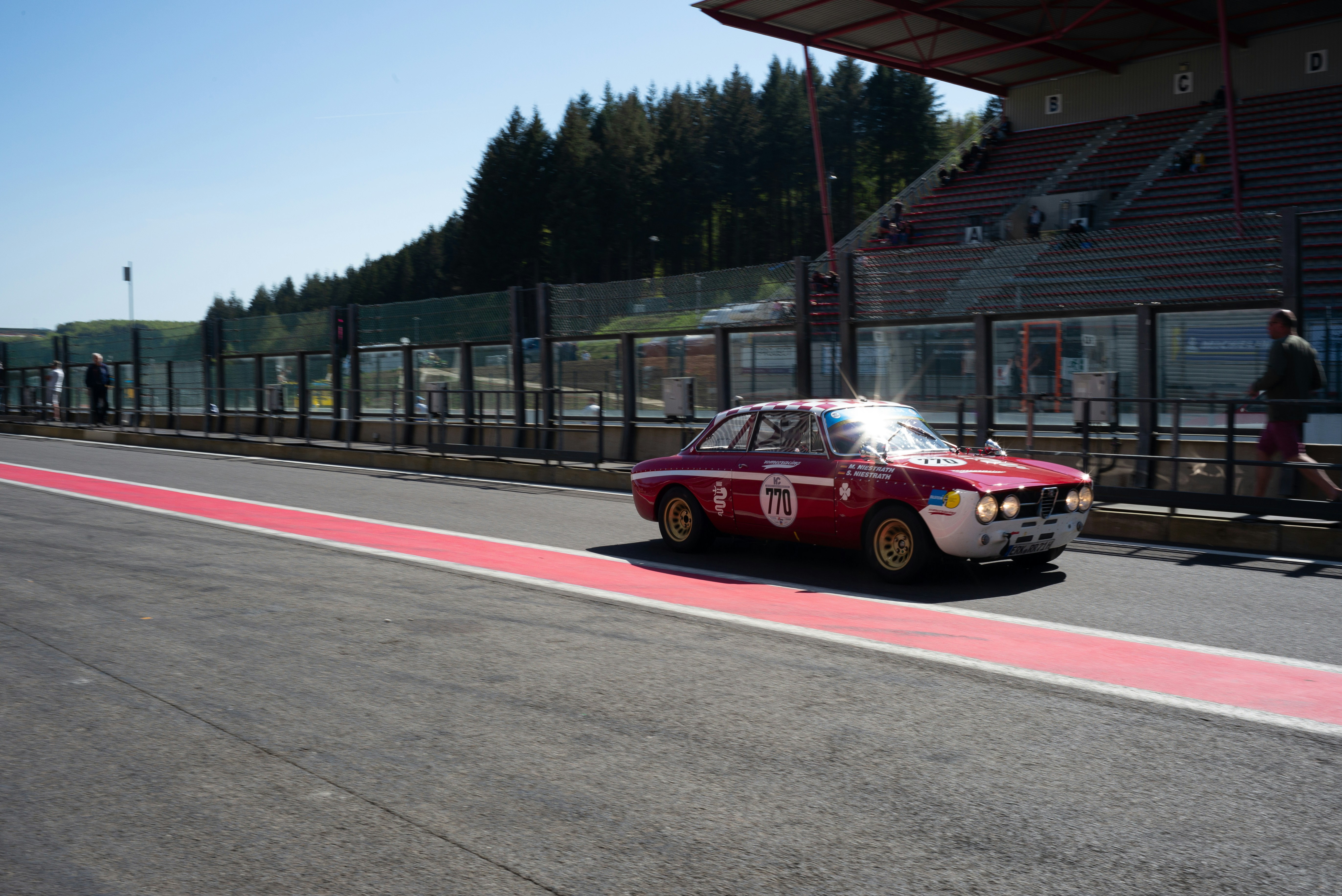Red Classic Rally Car on a Sunlit Pit Lane