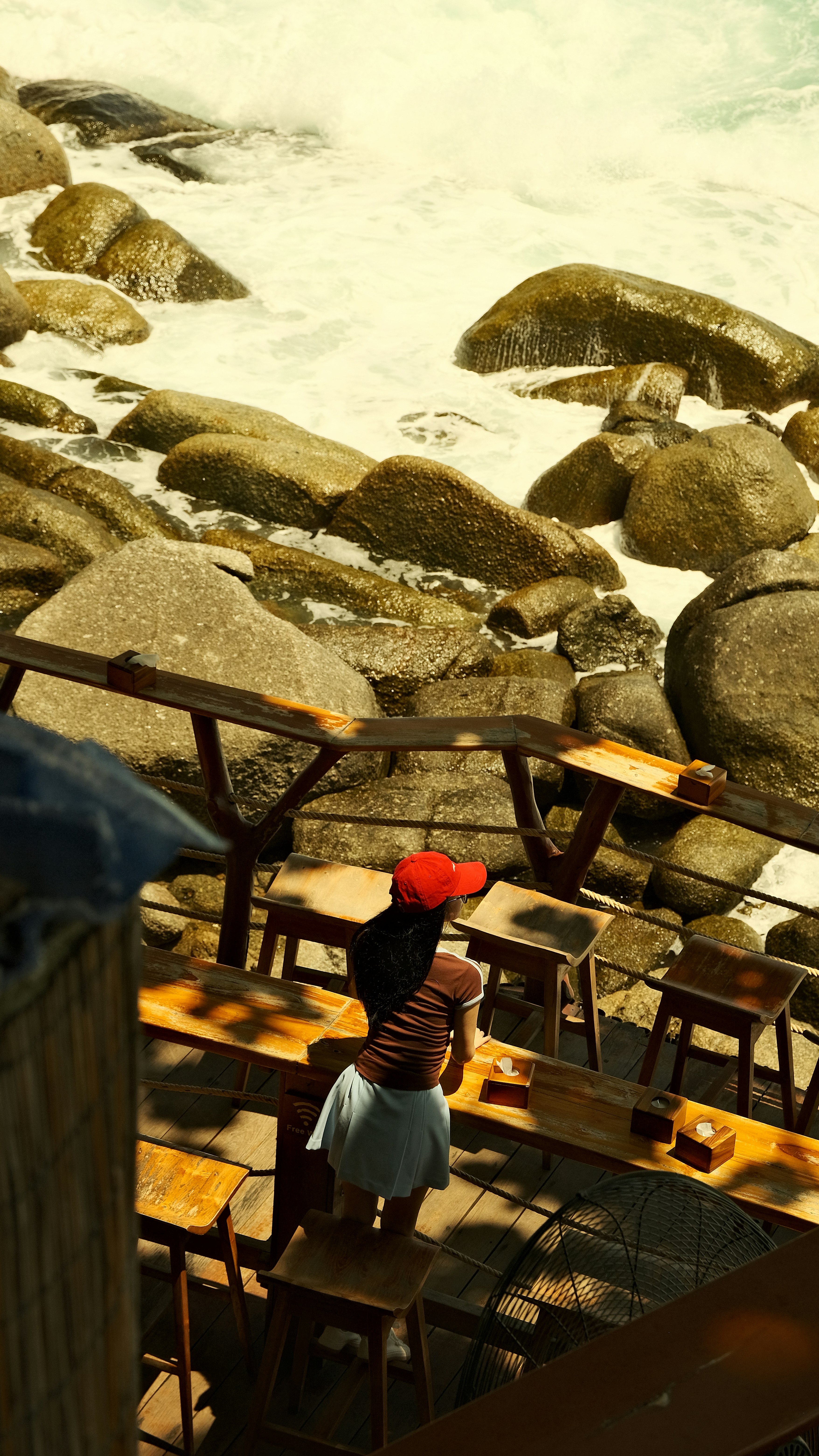Ocean Terrace: A Red-Capped Moment Amid Rolling Breakers