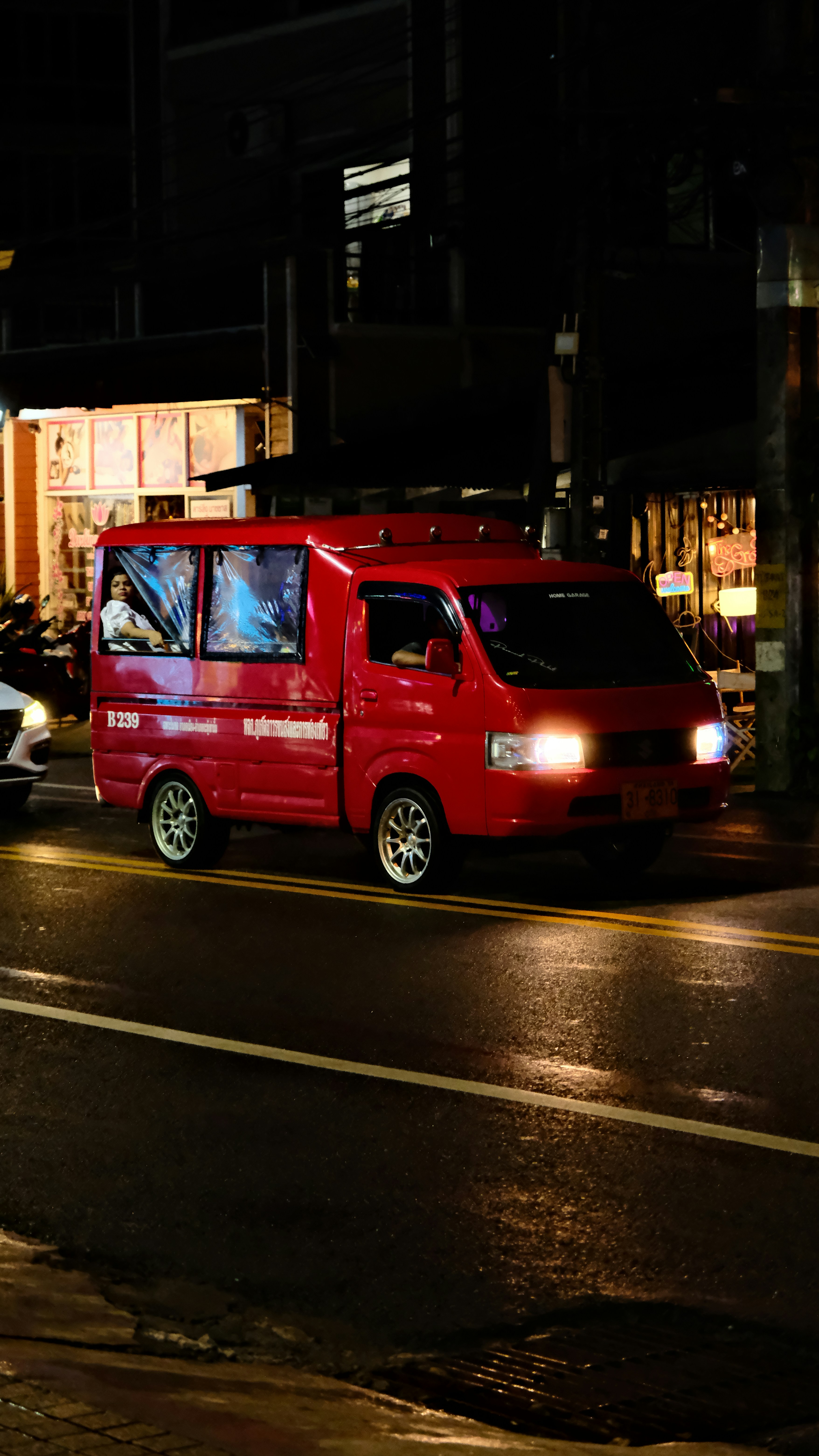 Red Bus at Night: Neon Reflections on a Quiet Street