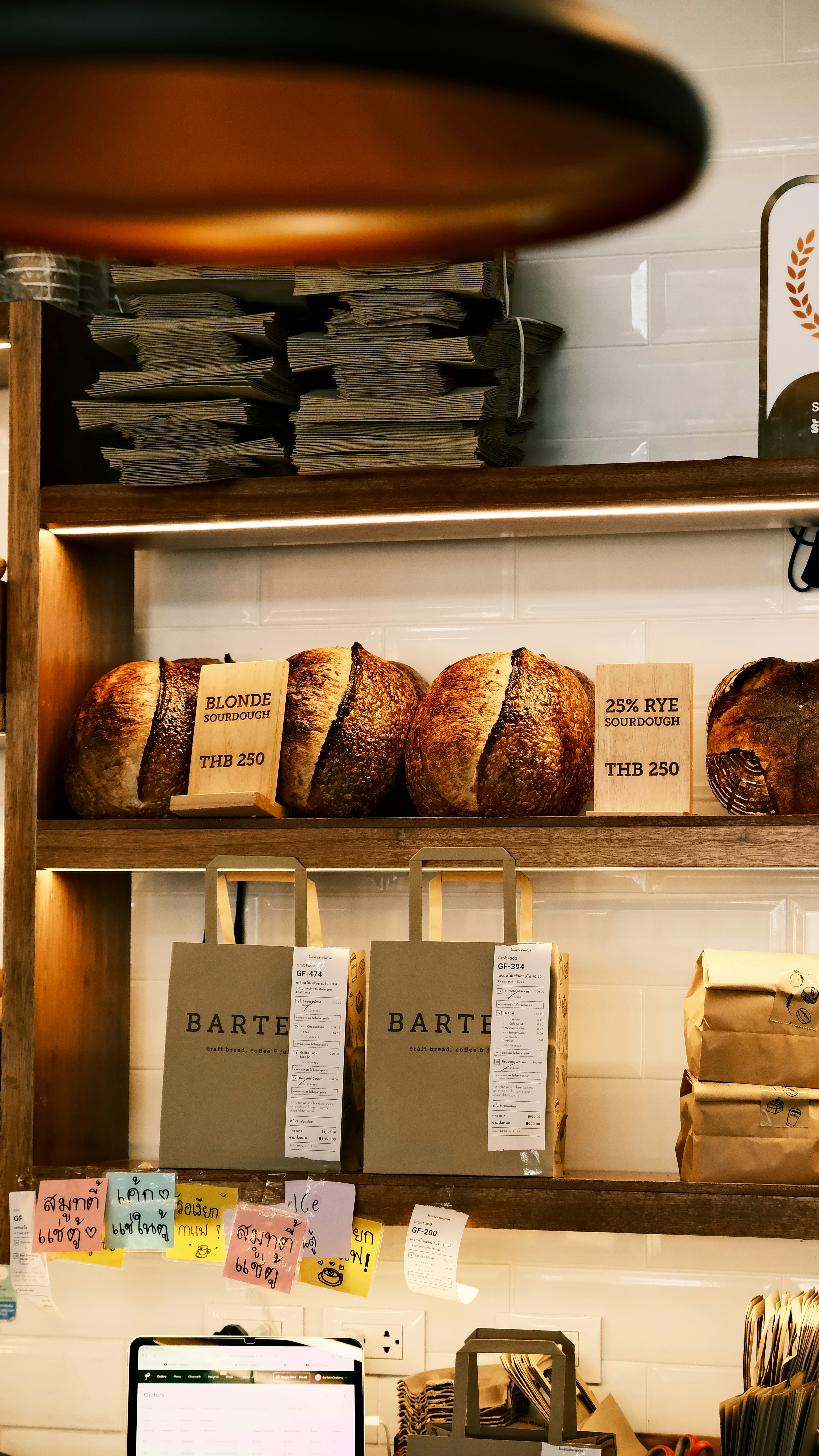 Stacks of Sourdough and Gift Bags in a Cozy Bakery Display