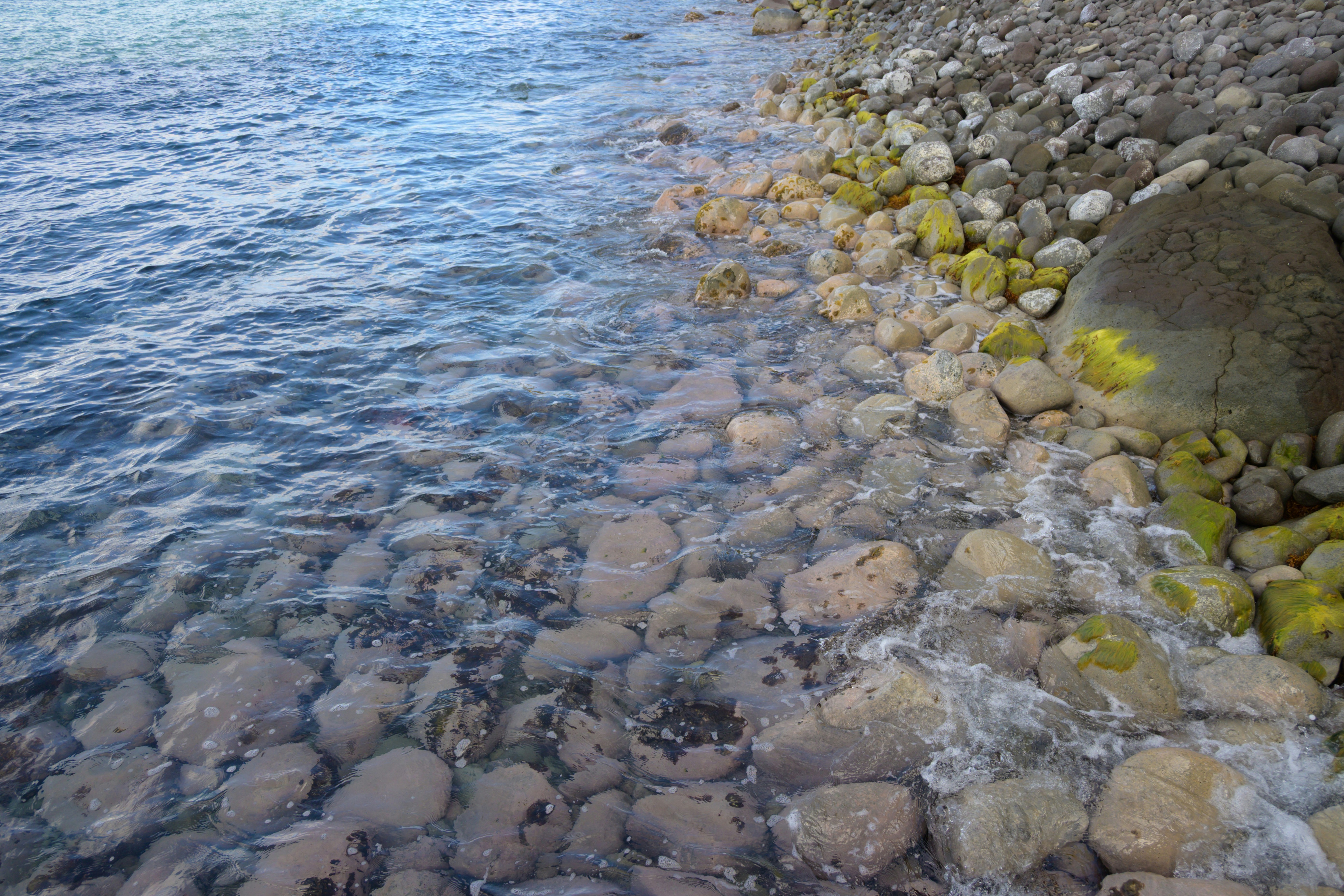 Tide over Stones: Calm Waters Lapping a Shingle Shore