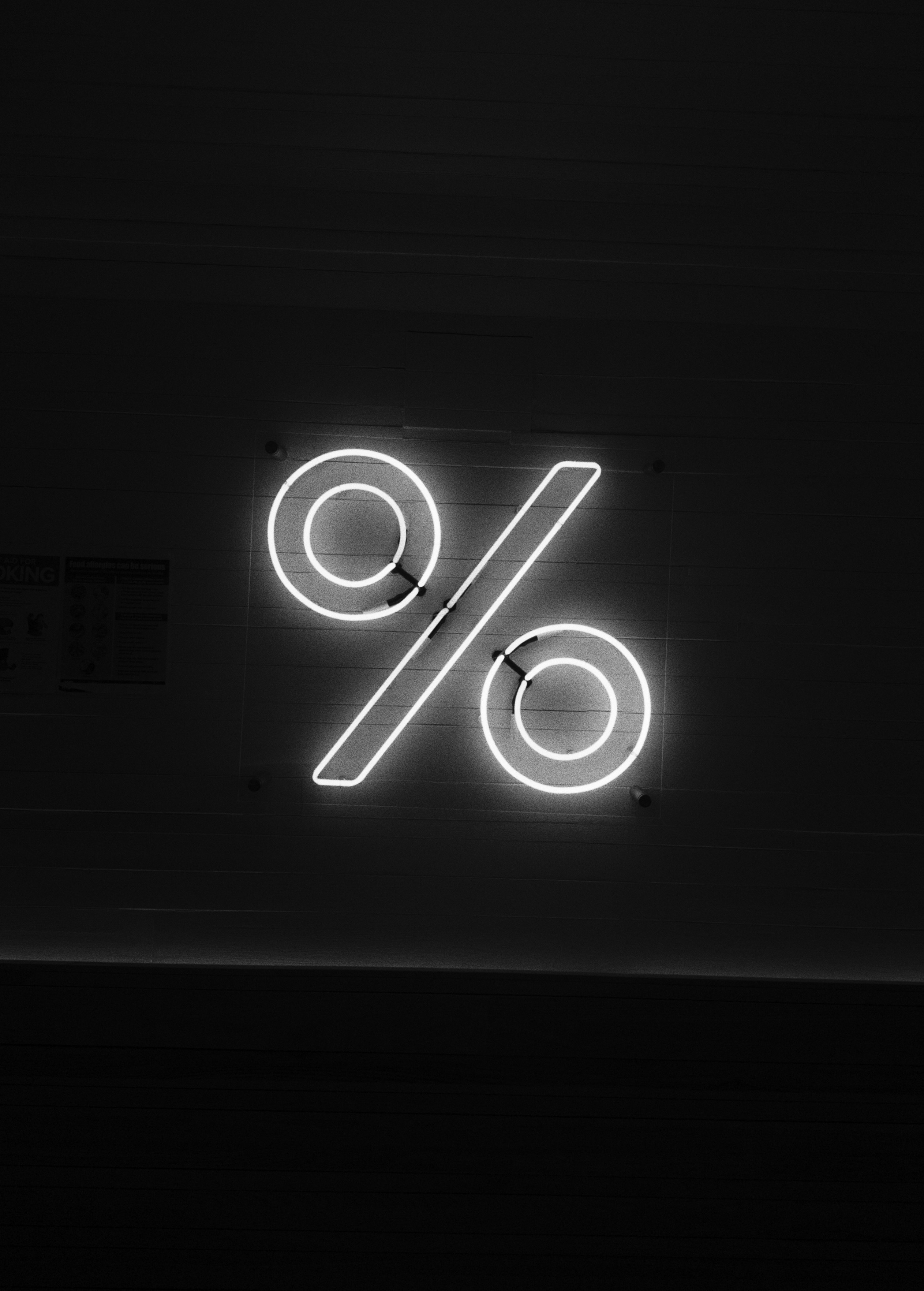 Neon Percent Sign in a Dark Corridor