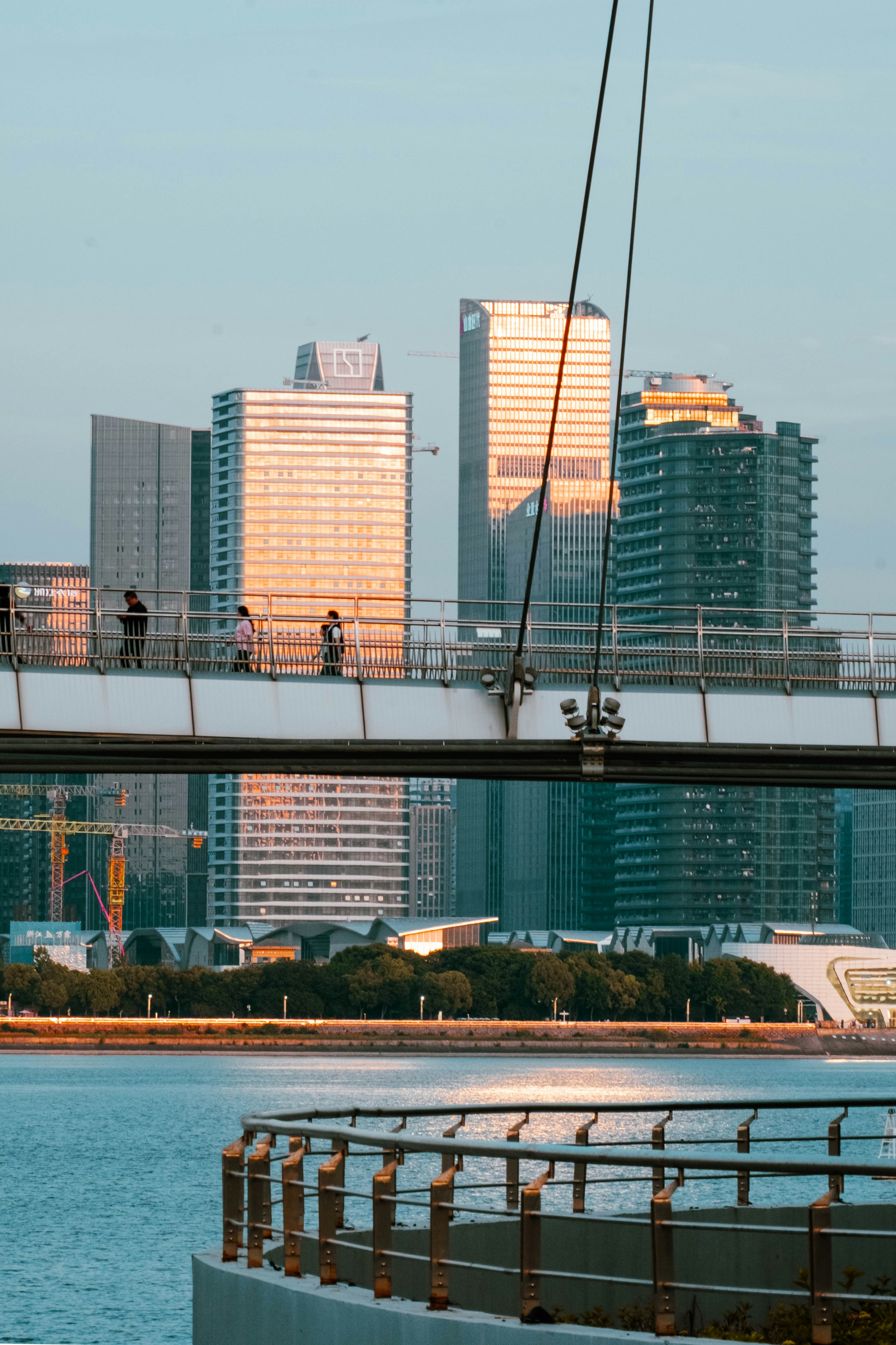 City Canvas: Pedestrians on a Suspended Pier Above Evening Waters