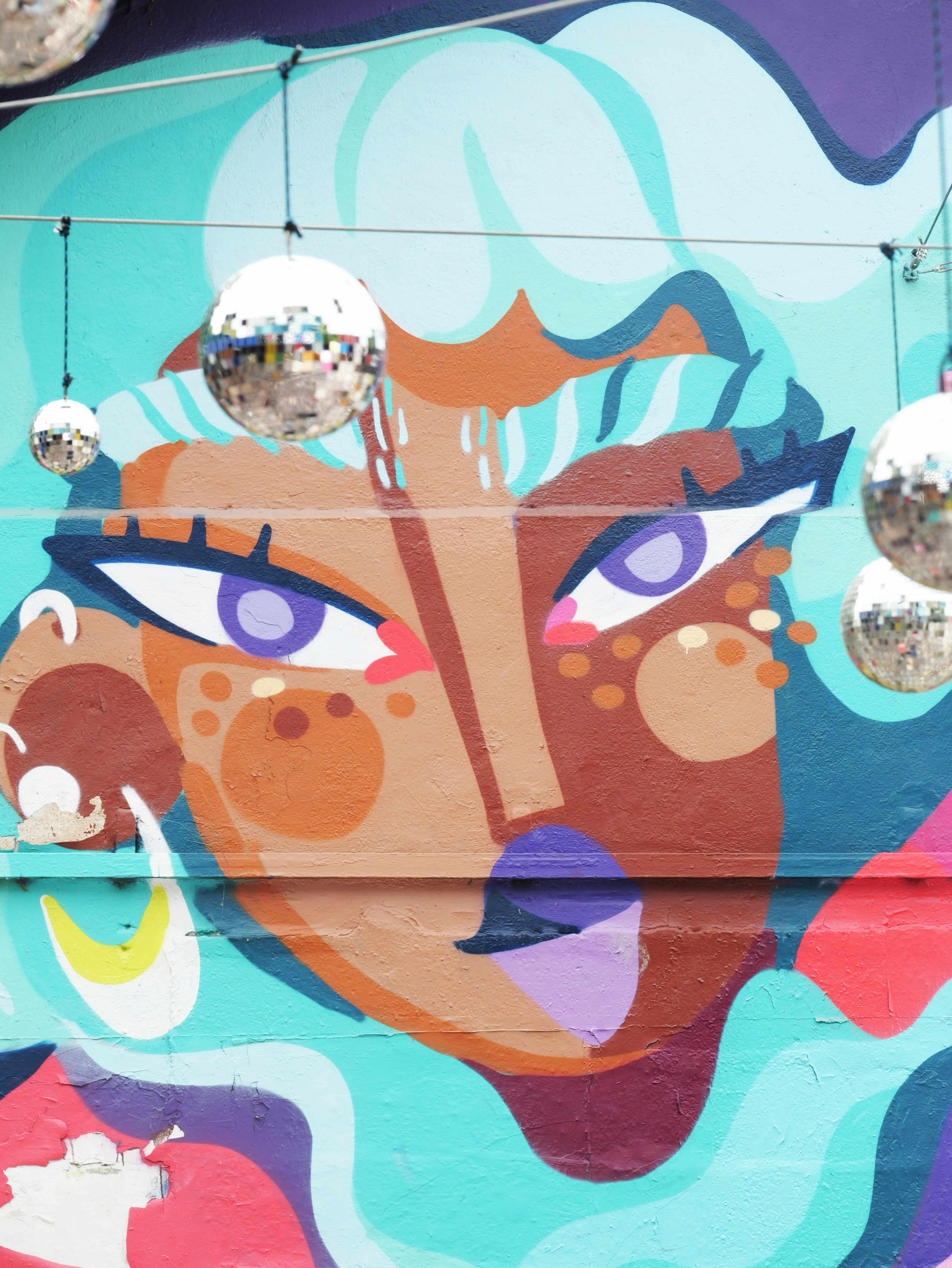 Vivid Mural Gaze: A Bold Face in Color and Reflection