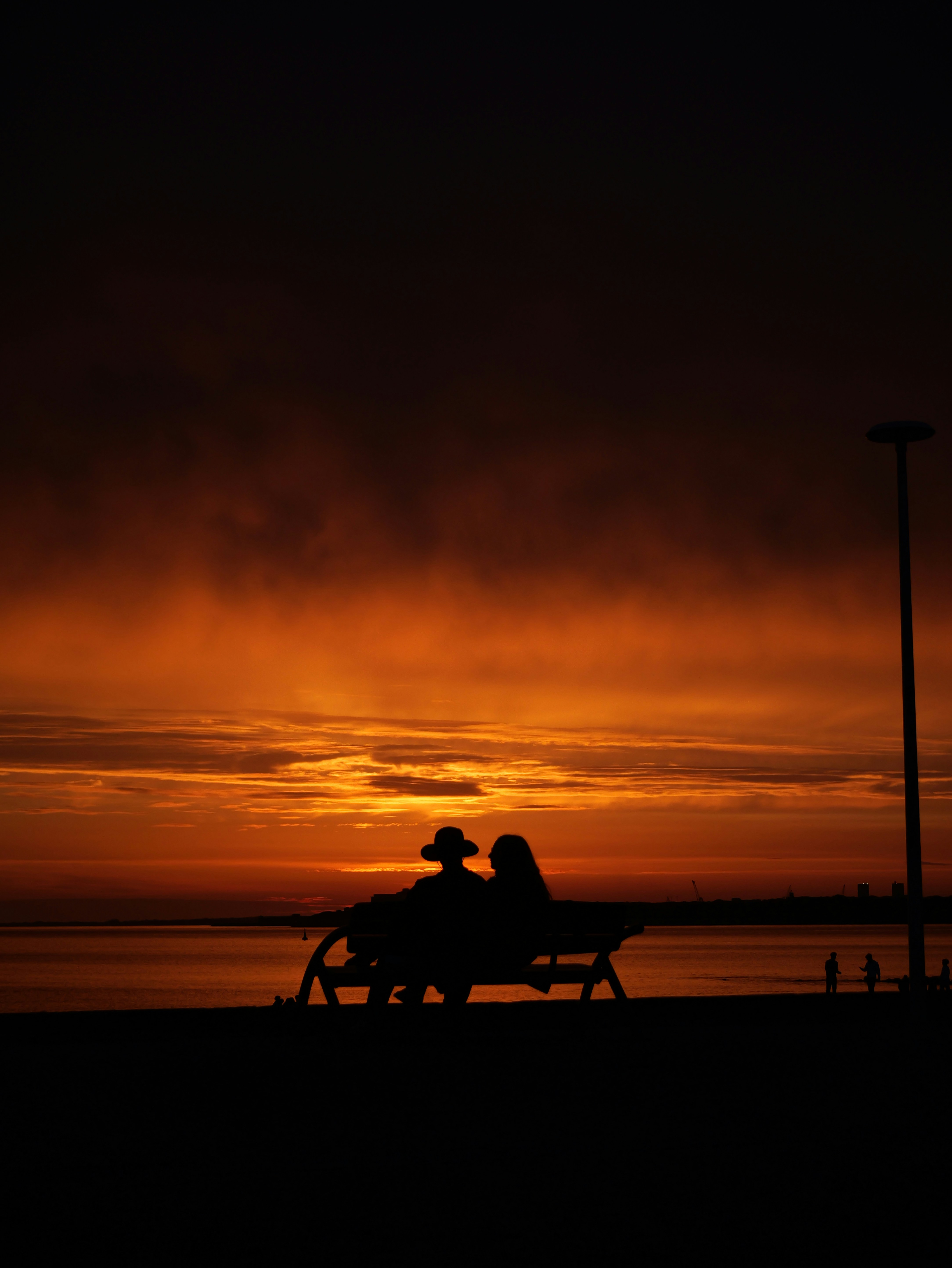Silhouettes on a Sunset Pier