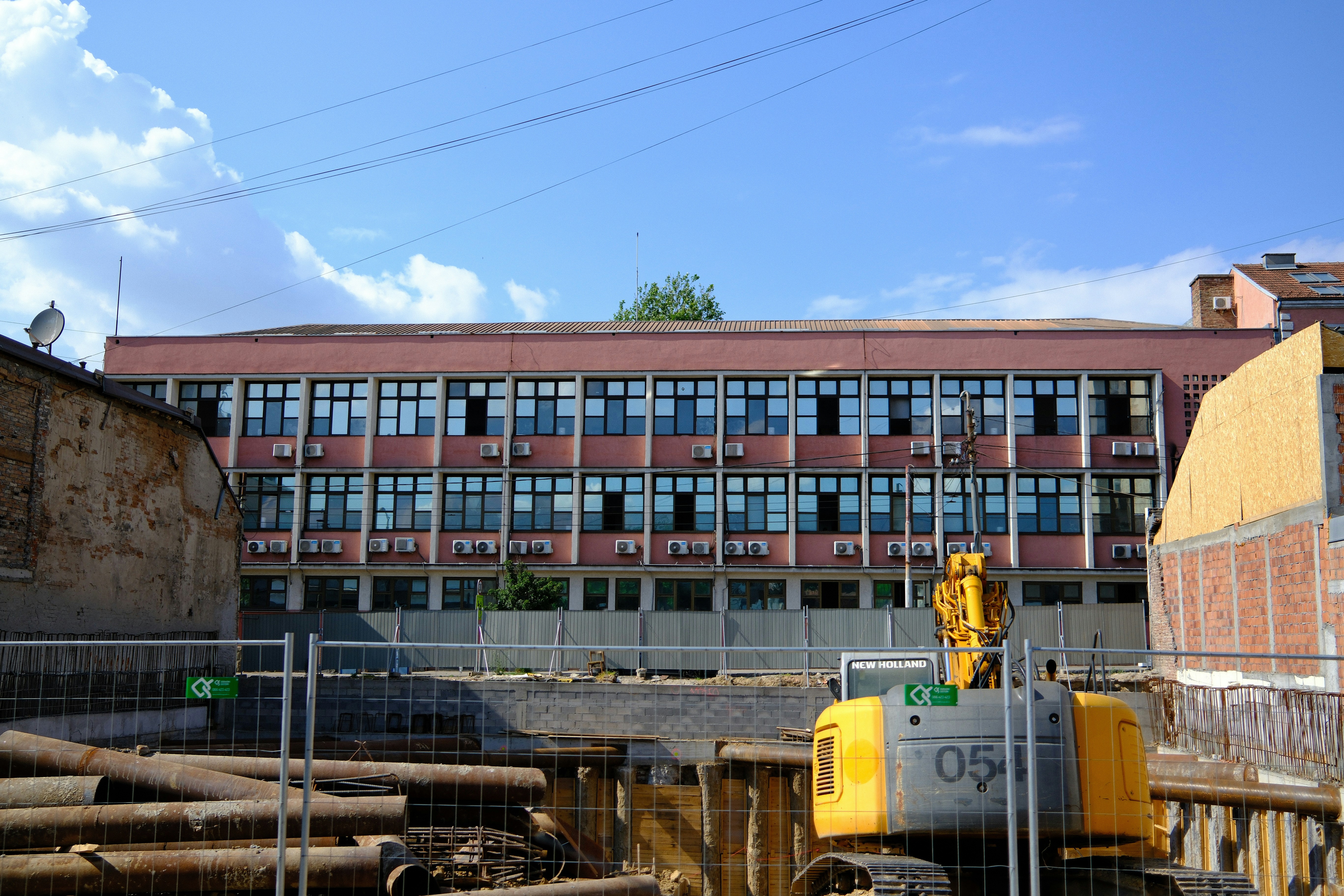 Construction Maelstrom Beneath a Facade of Windows