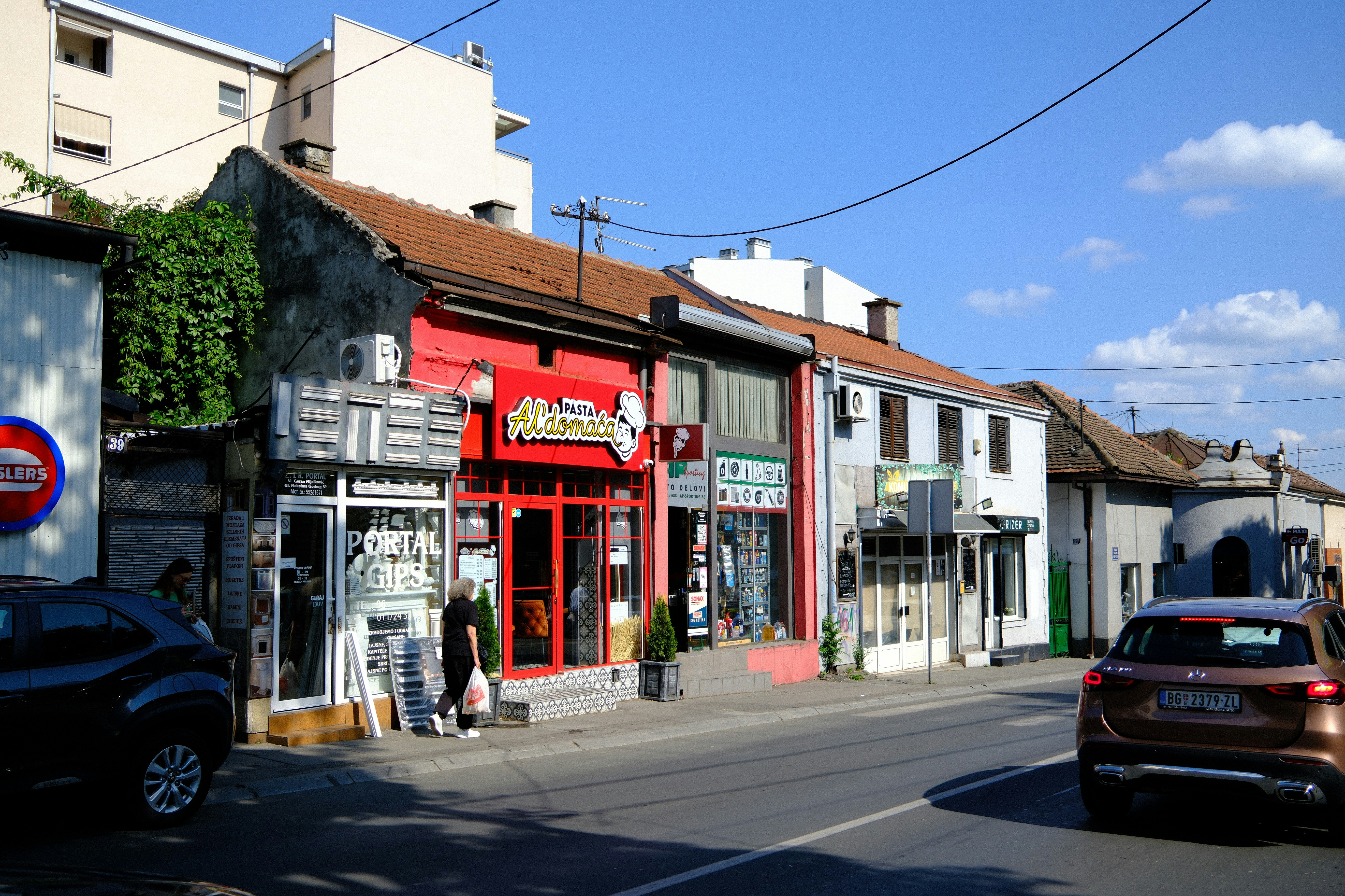 Colorful storefronts and sunlit street bustle