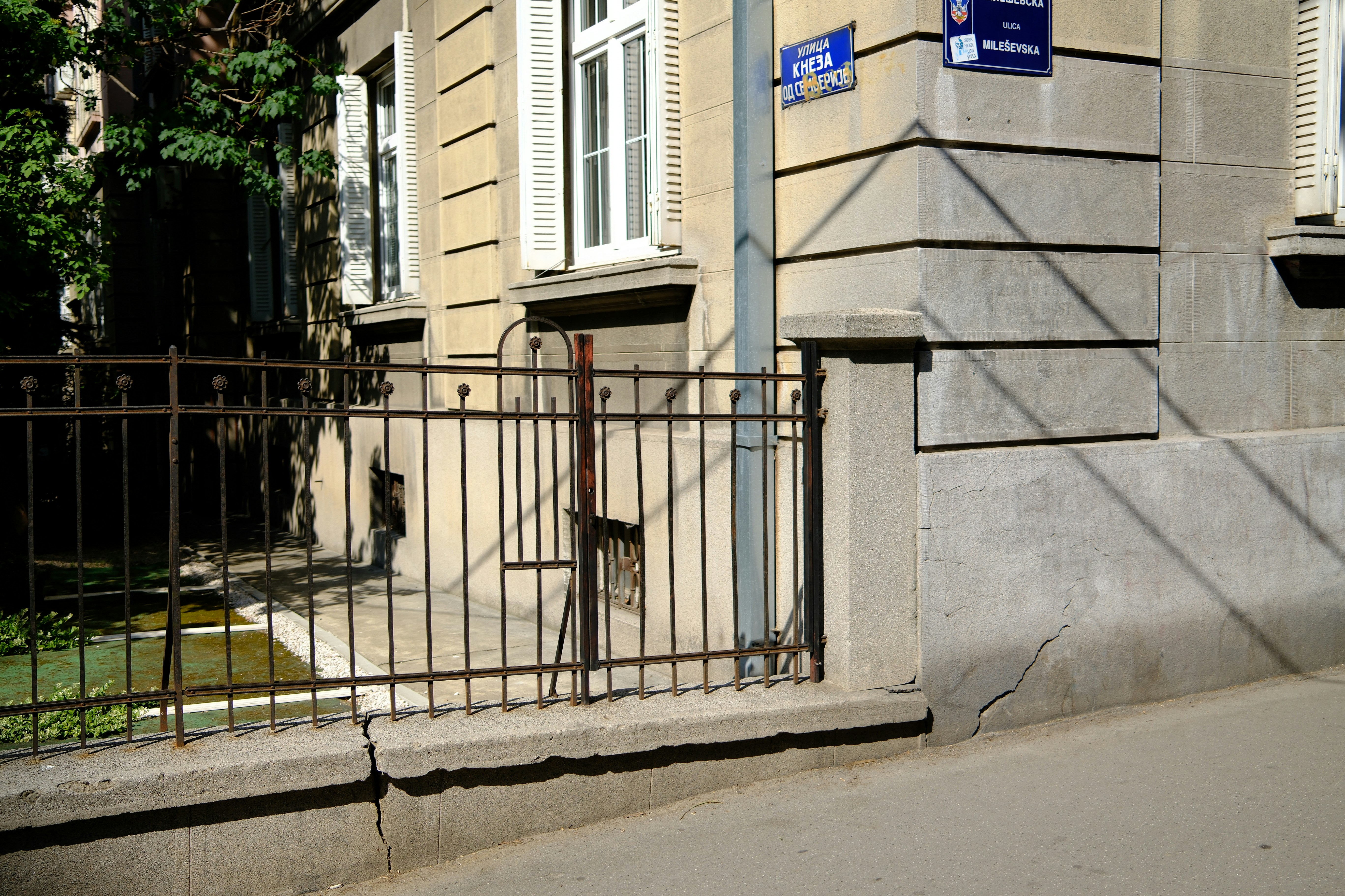 Quiet Street Boundary: Iron Railing and Corner Facade