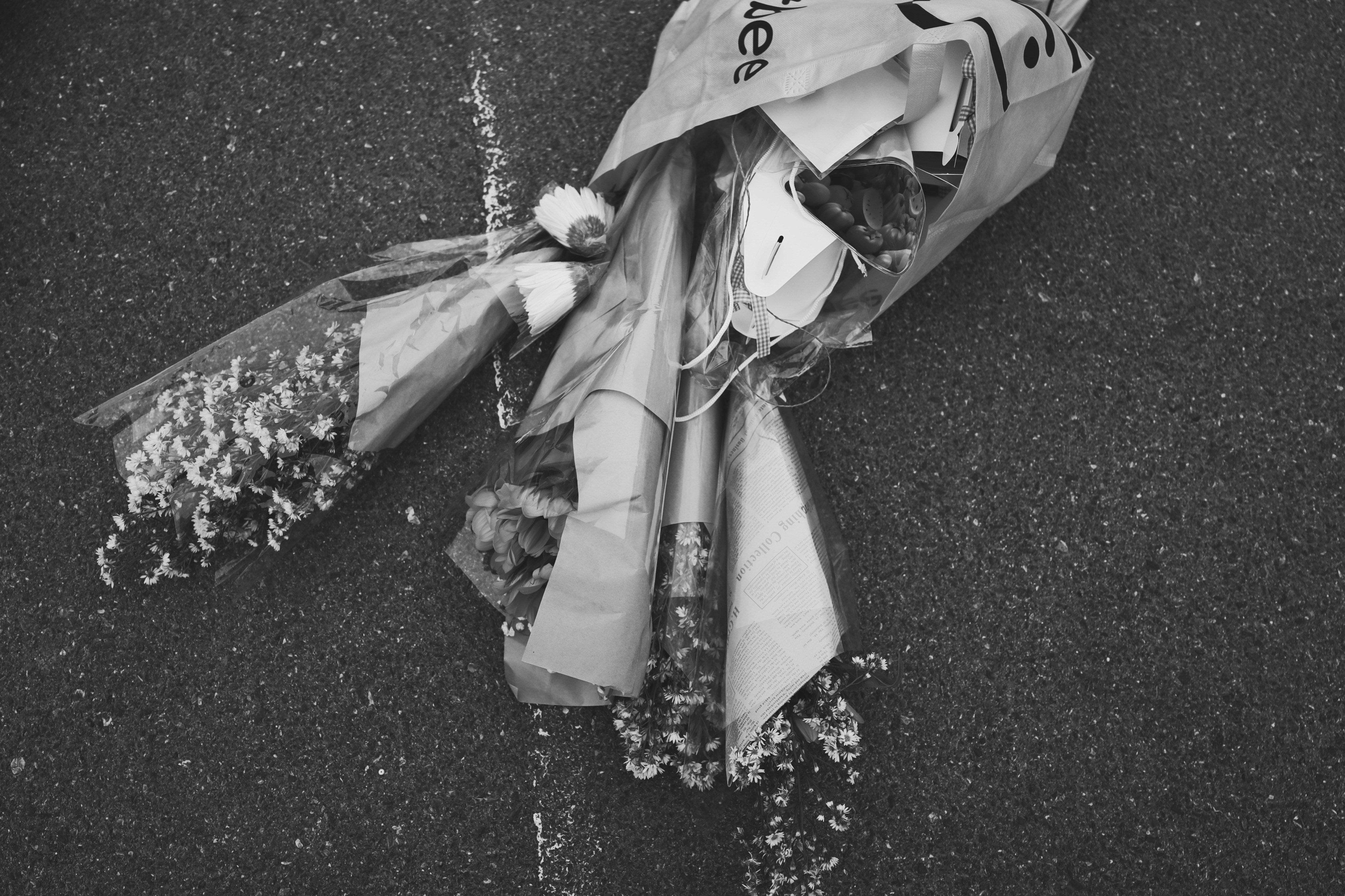 Ragged Bouquet on Asphalt: A Quiet Moment of Decay
